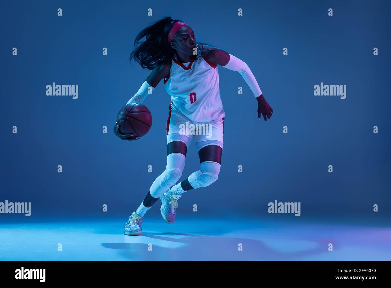 Beautiful african-american female basketball player in motion and ...