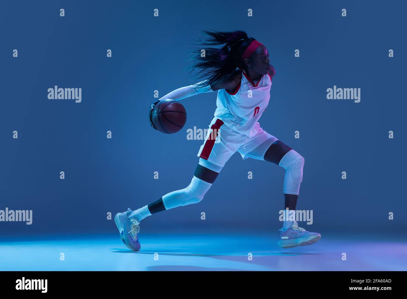Beautiful african-american female basketball player in motion and ...