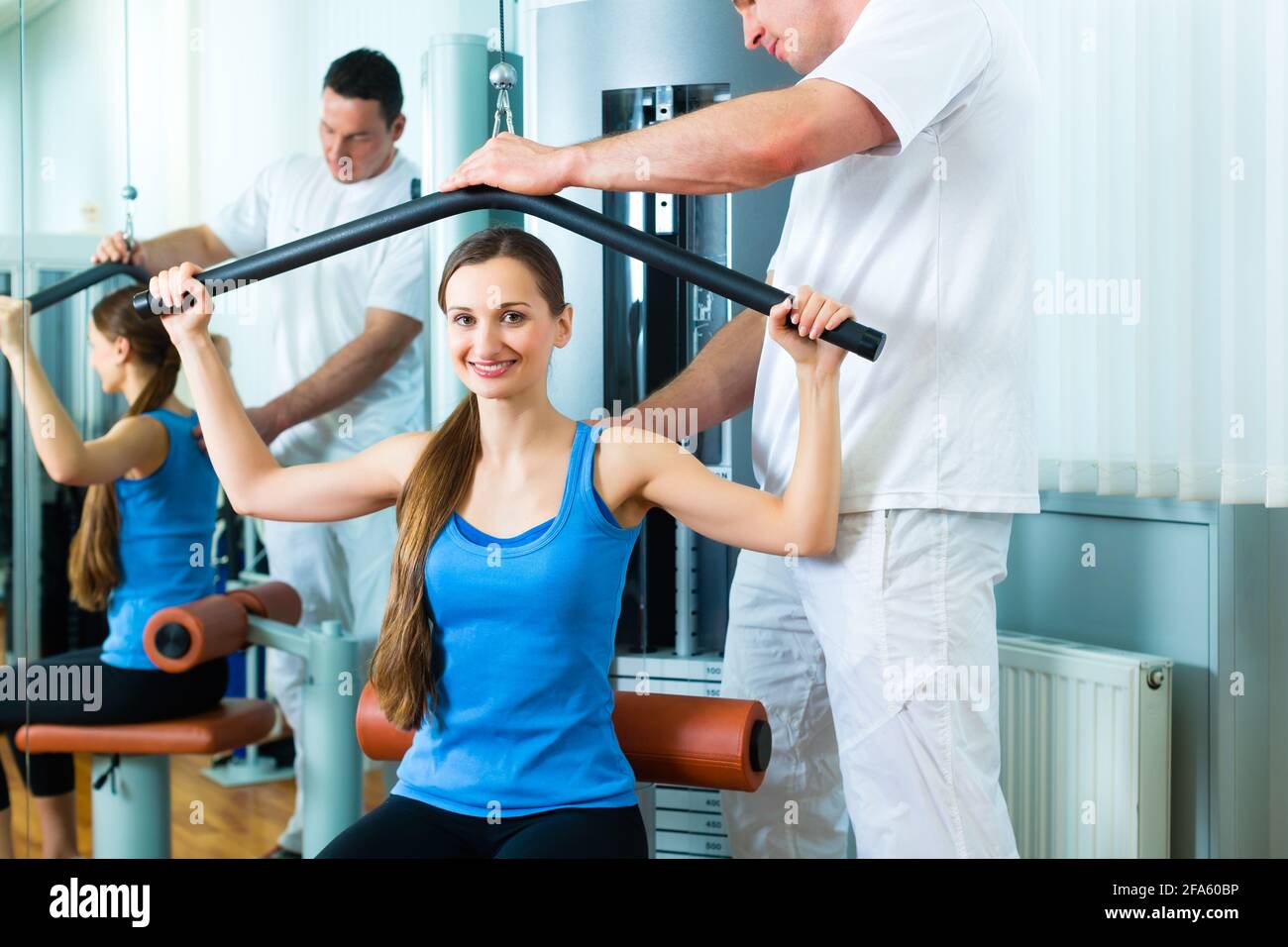 Patient at the physiotherapy making physical exercises with her ...