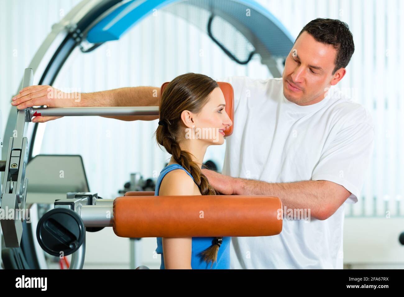 Patient at the physiotherapy making physical exercises with her ...