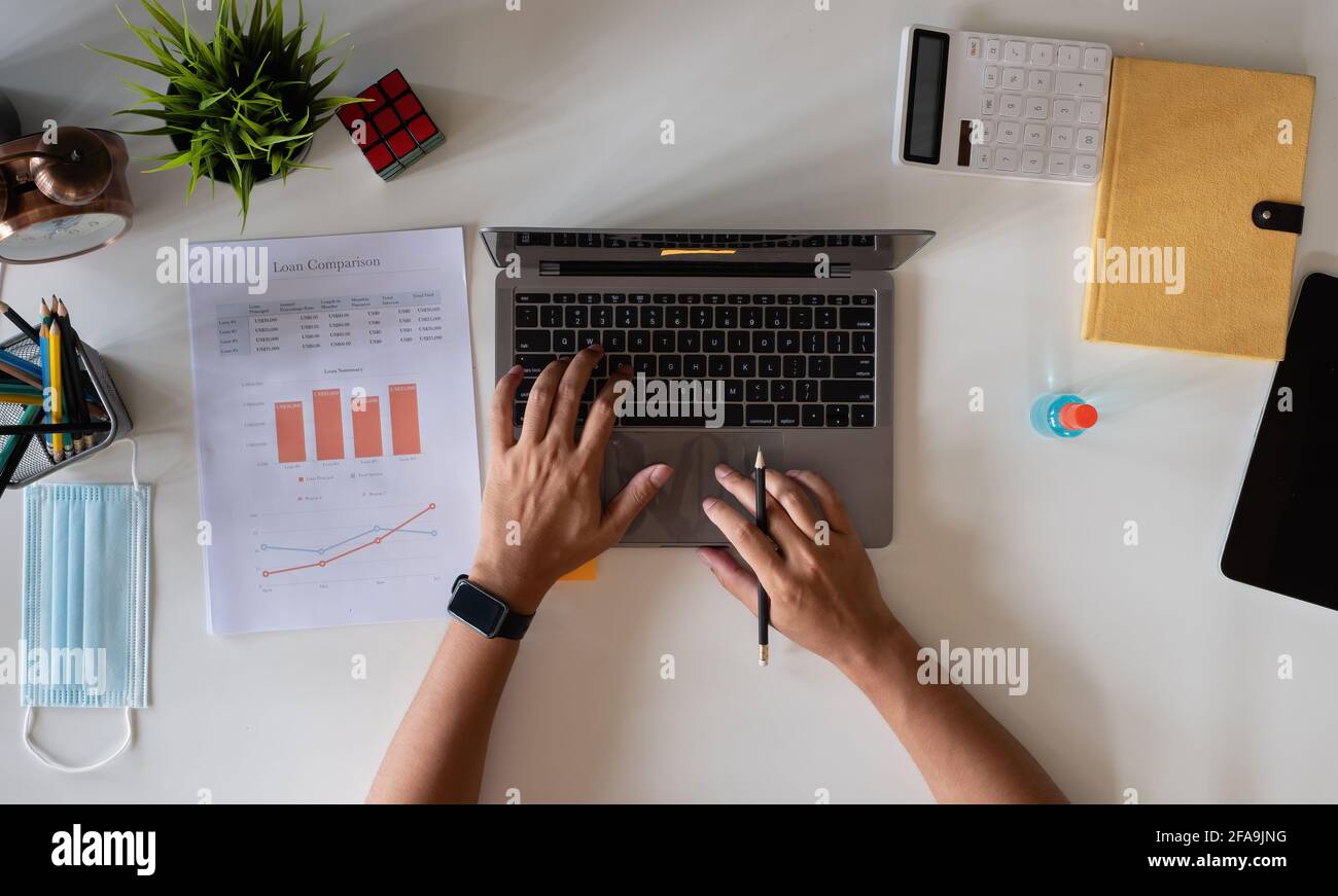 Top view of males hand using laptop om working desk - work from home ...