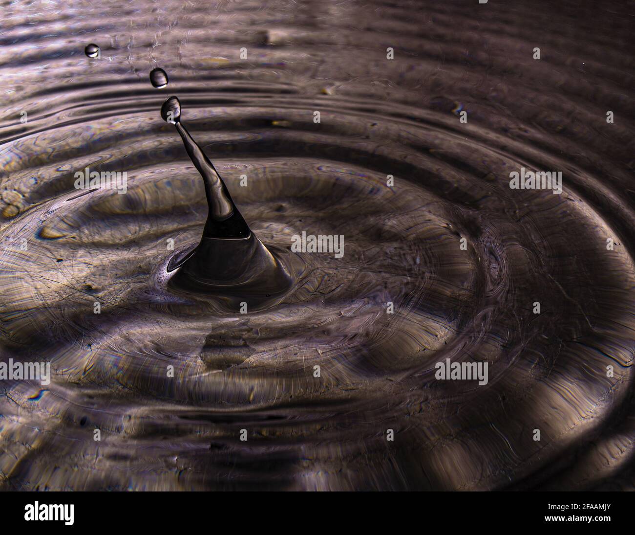 Water drop splash creating ripples Stock Photo - Alamy