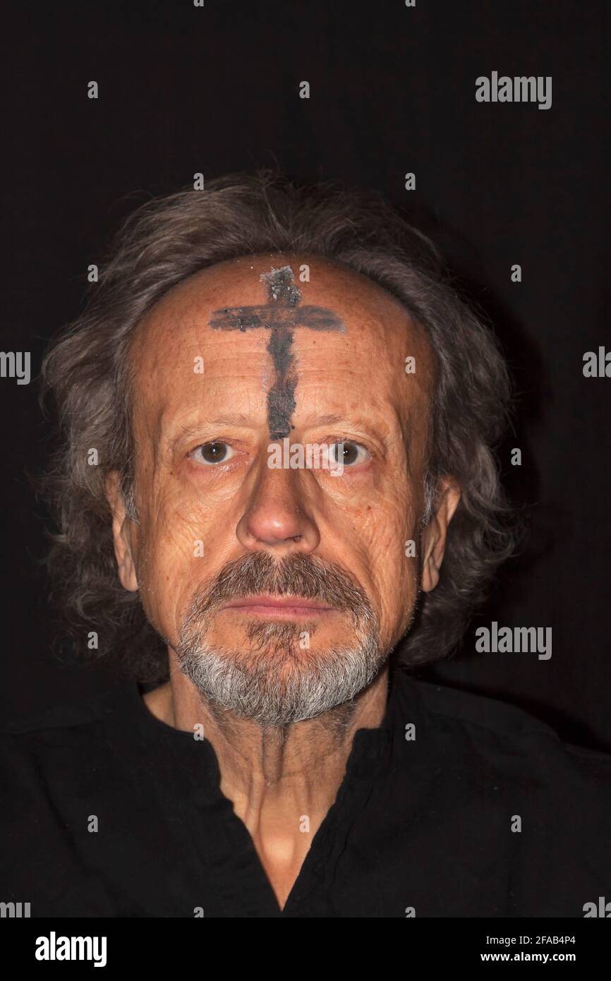 Fanatical prayer with ash cross on his forehead Stock Photo - Alamy