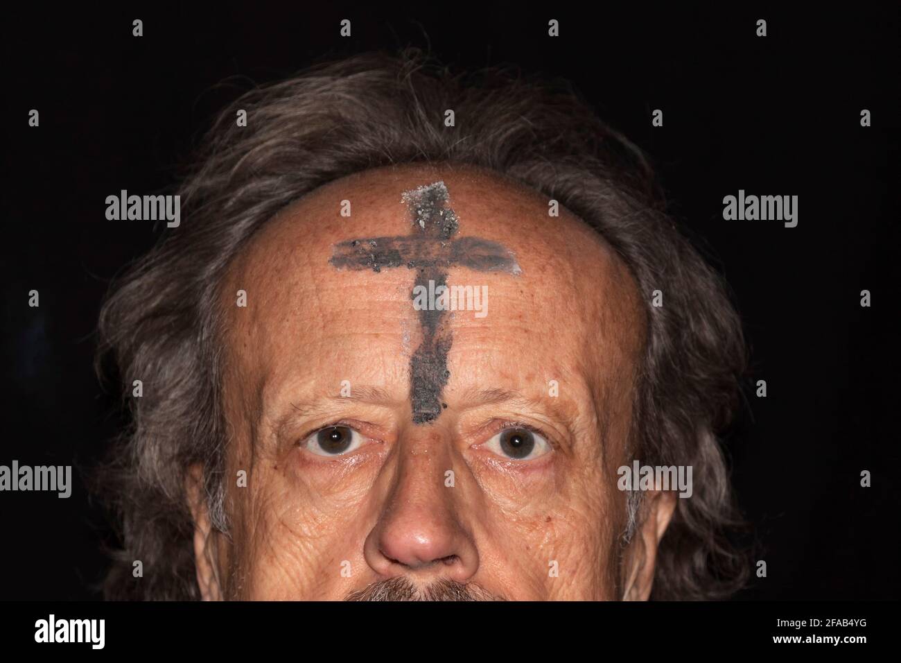 Fanatical prayer with ash cross on his forehead Stock Photo - Alamy