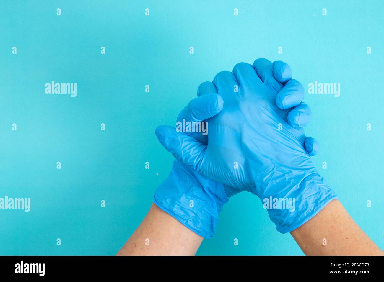 hands wearing blue glove, holding hands to supporting Stock Photo - Alamy