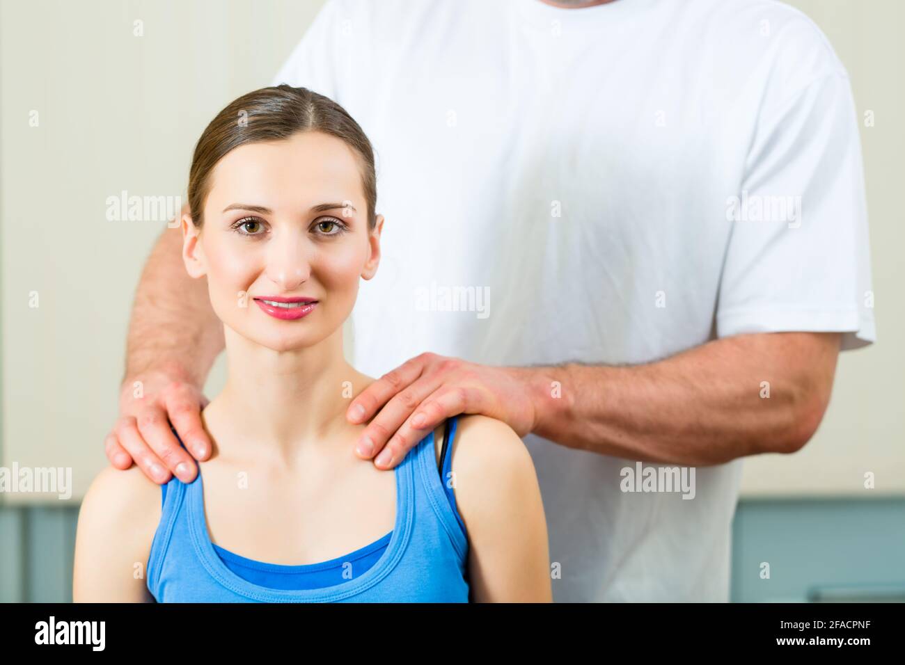 Female Patient at the physiotherapy doing physical exercises with her ...
