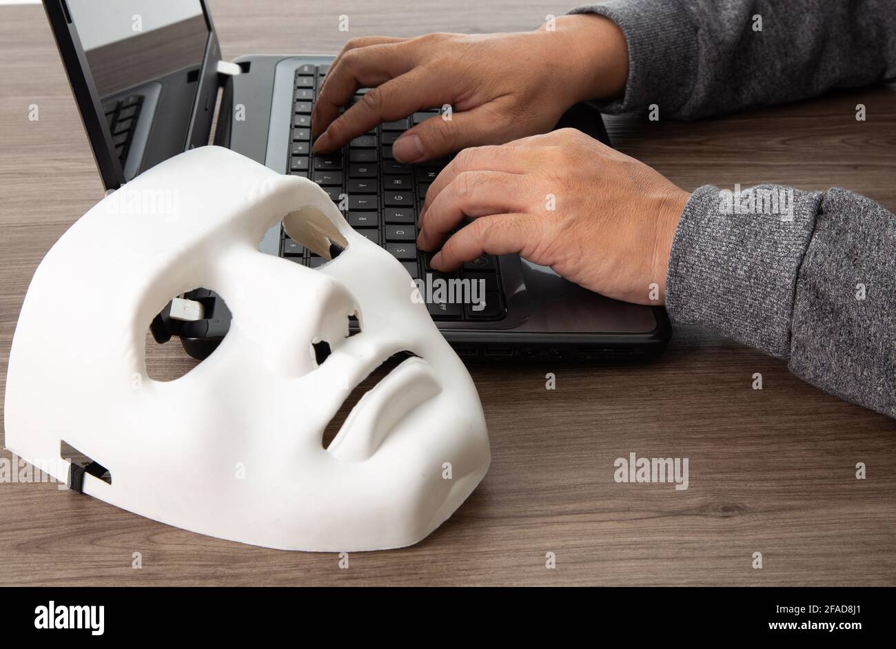 Thief hacker in mask stealing personal information from laptop. Concept ...