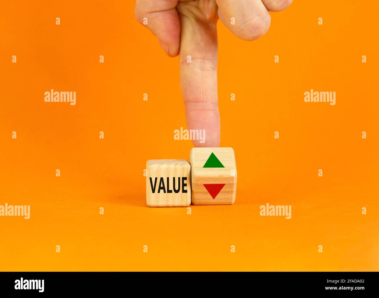 Value rates symbol. Businessman turns a cube, changes the direction of ...