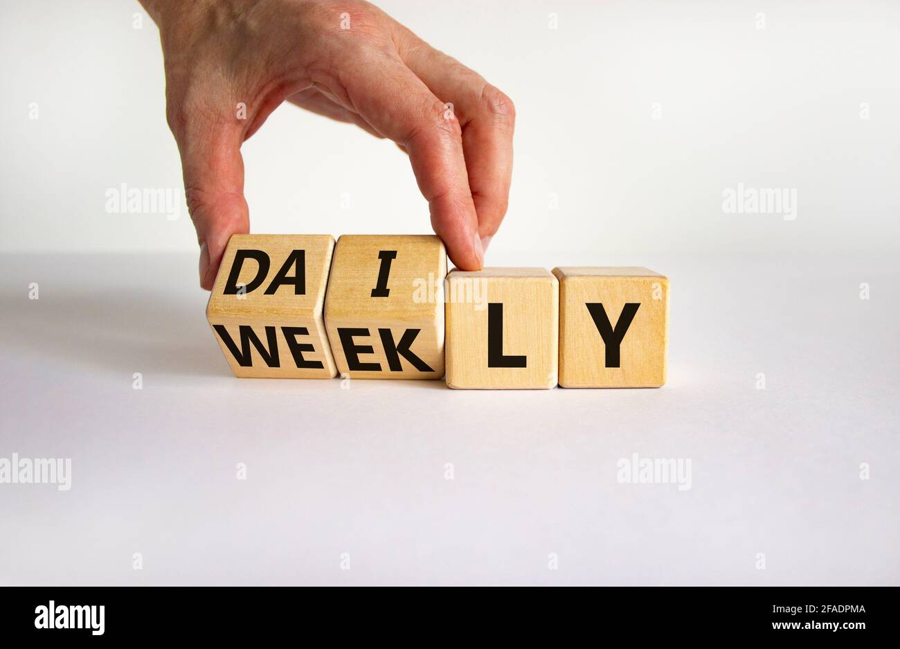 Daily or weekly symbol. Businessman turns wooden cubes and changes the ...