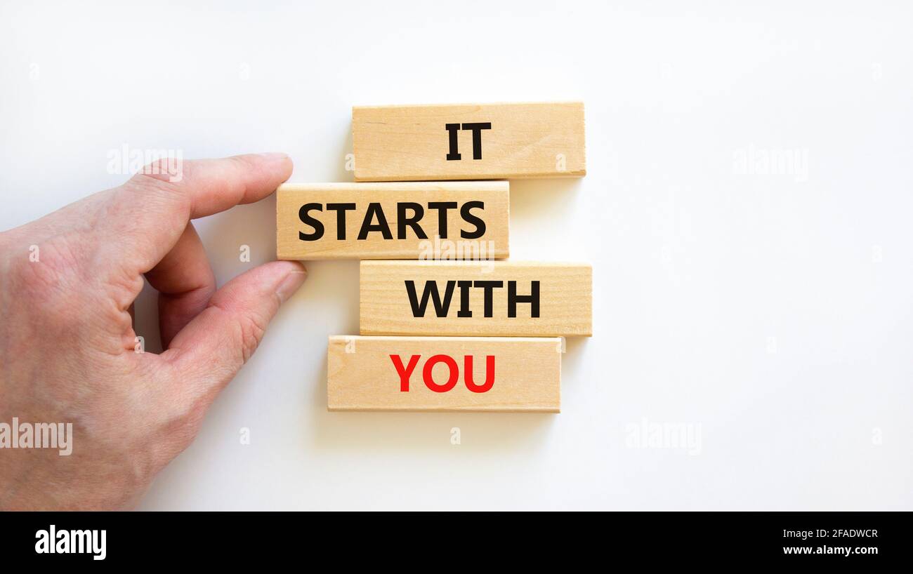 It starts with you symbol. Wooden blocks with words 'it starts with you ...