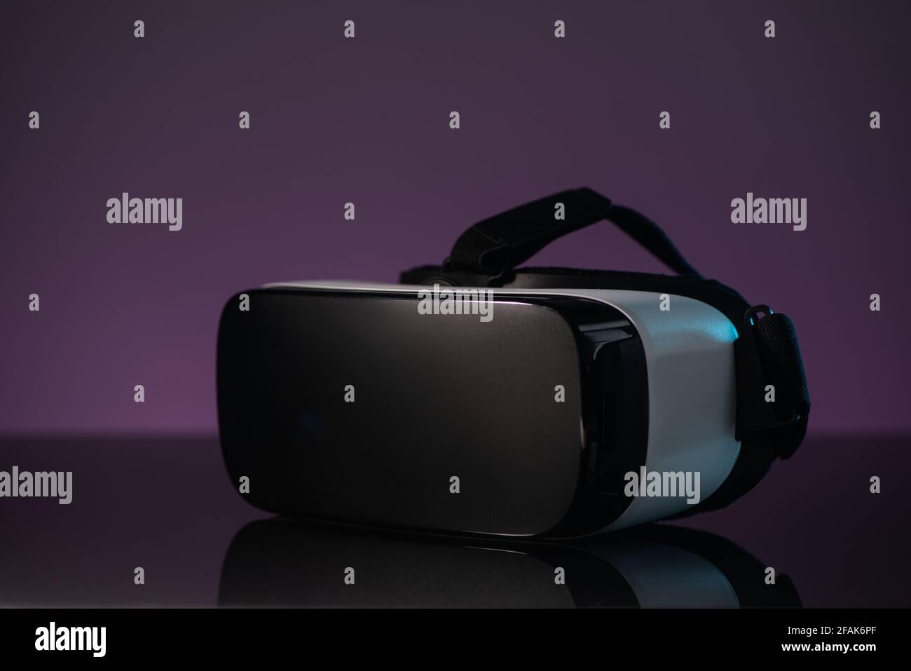 White VR headset on dark violet background Stock Photo - Alamy