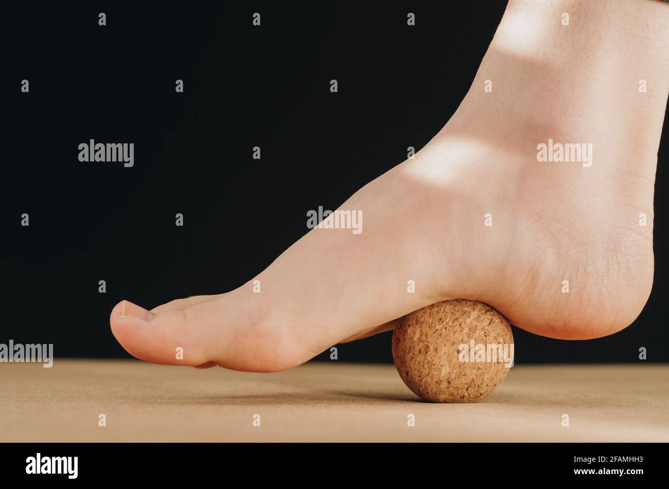 Artistic isolated close up video of foot on cork massage ball on cork ...