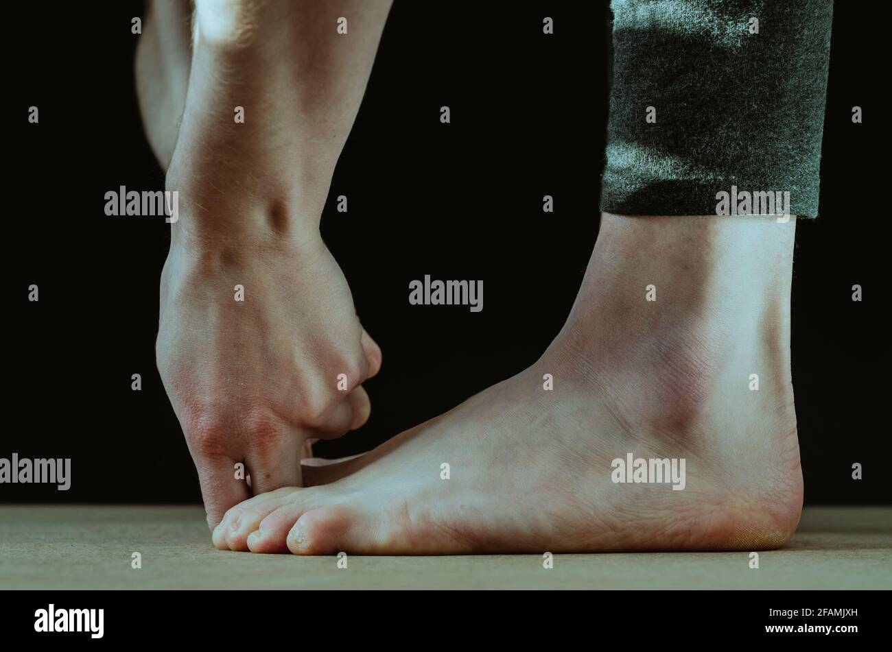 Close up of feet and fingers bound to big toes yoga pose ...
