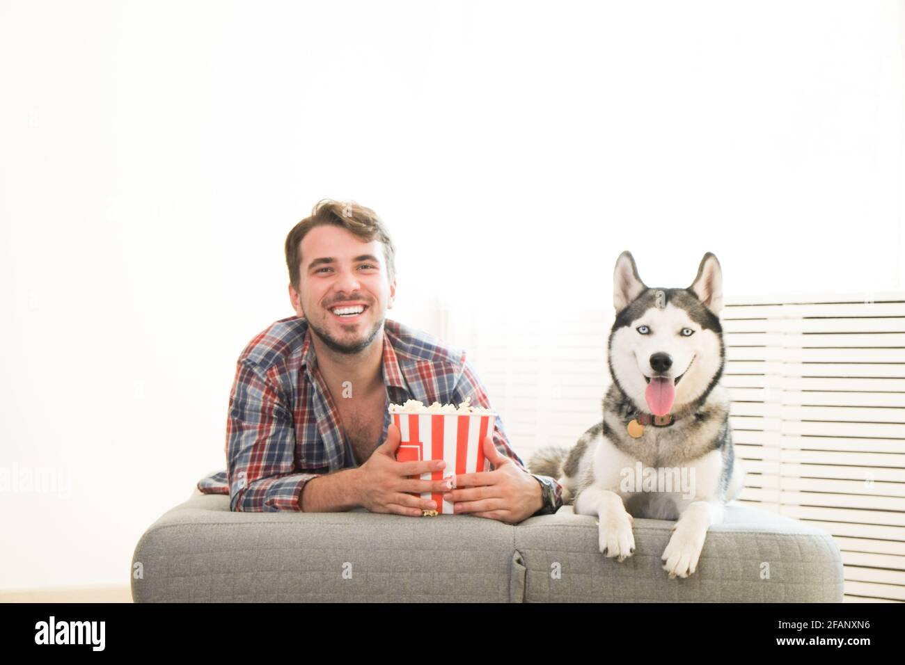 Young bearded man hanging out out with his husky dog. Hipster male ...