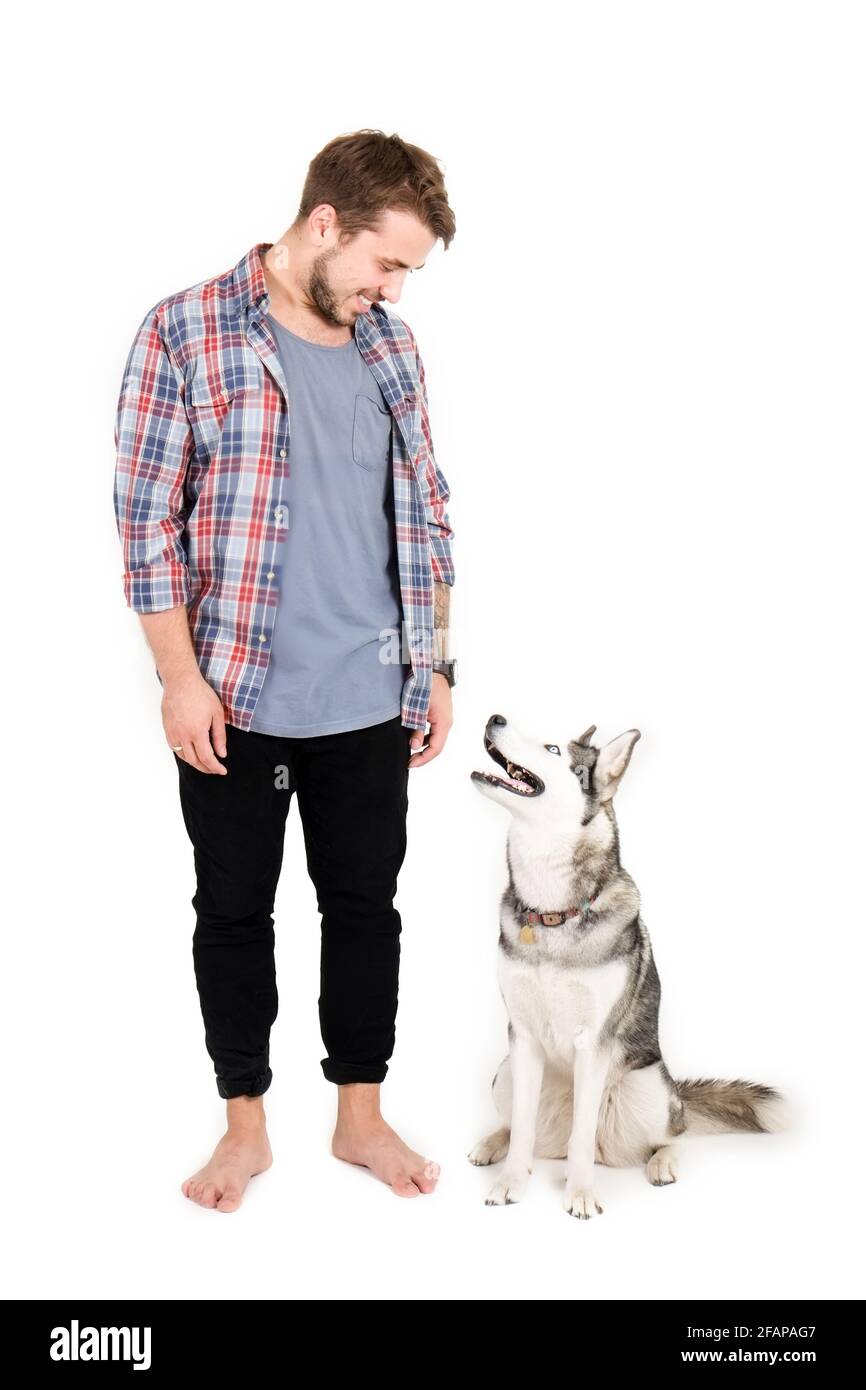 Young bearded man hanging out out with his husky dog. Hipster male ...