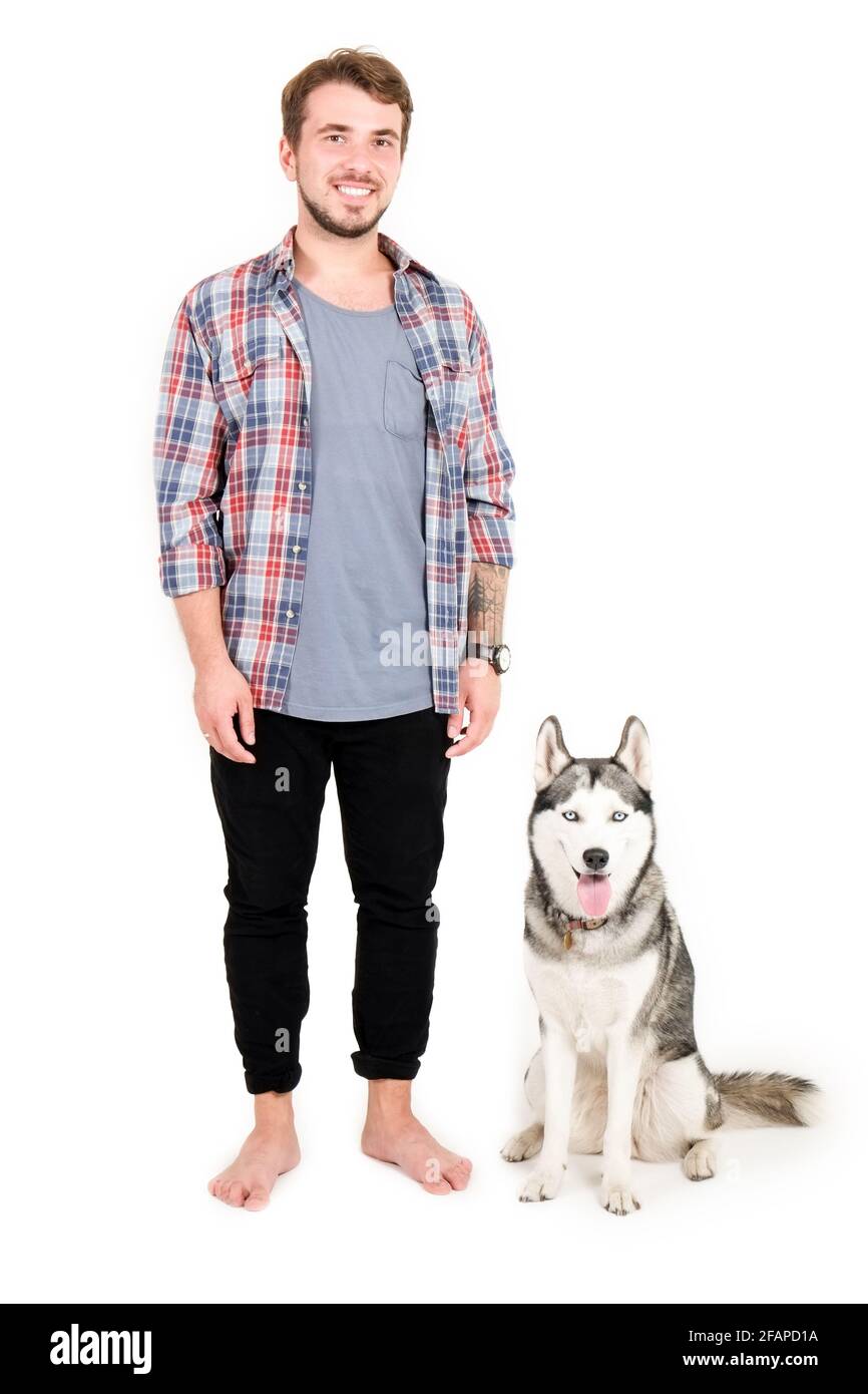 Young bearded man hanging out out with his husky dog. Hipster male ...