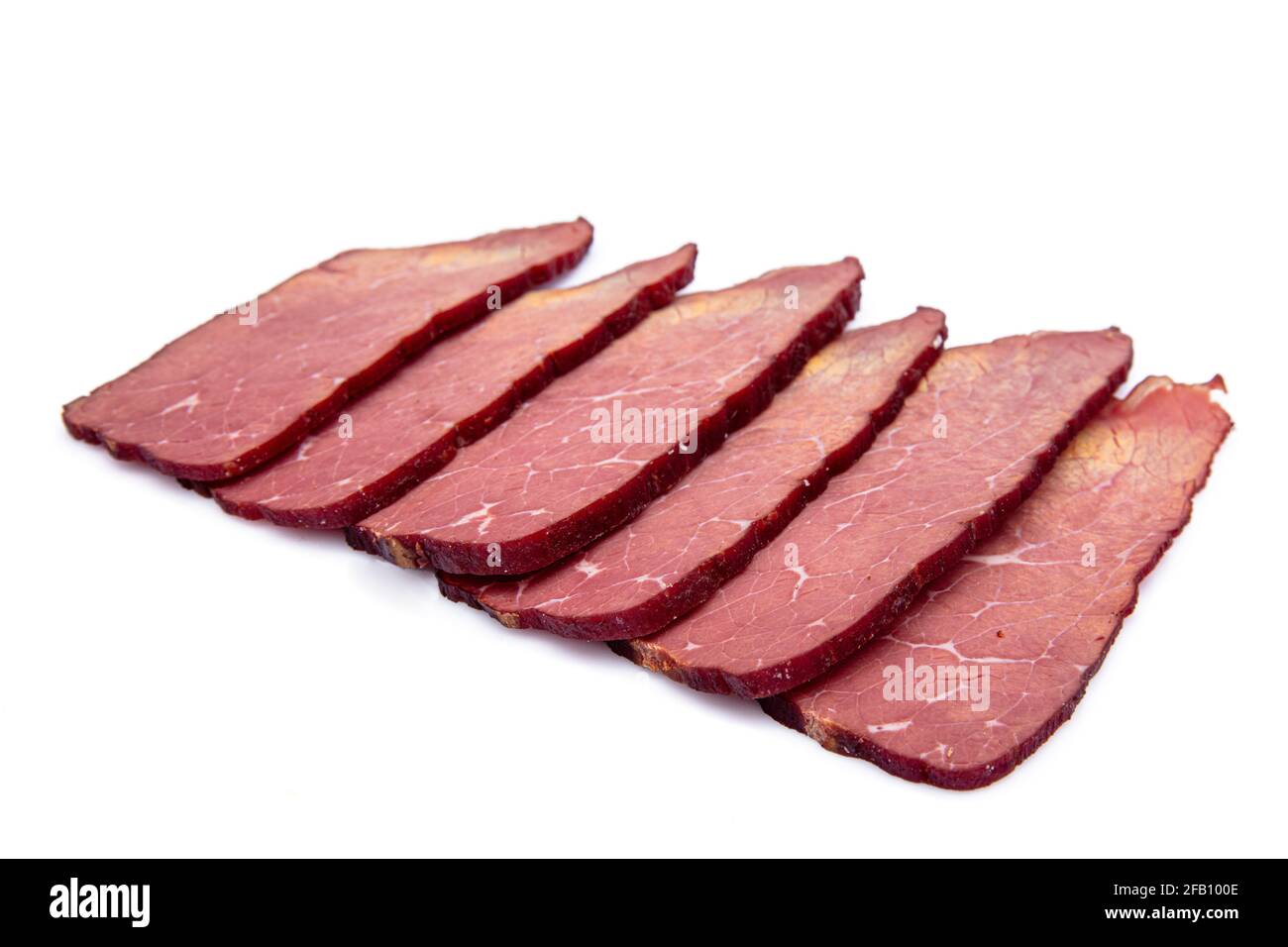 Dried meat slices. Beef jerky pieces isolated on a white background ...
