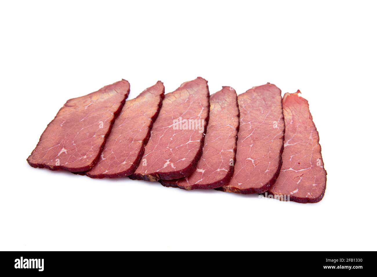 Dried meat slices. Beef jerky pieces isolated on a white background ...