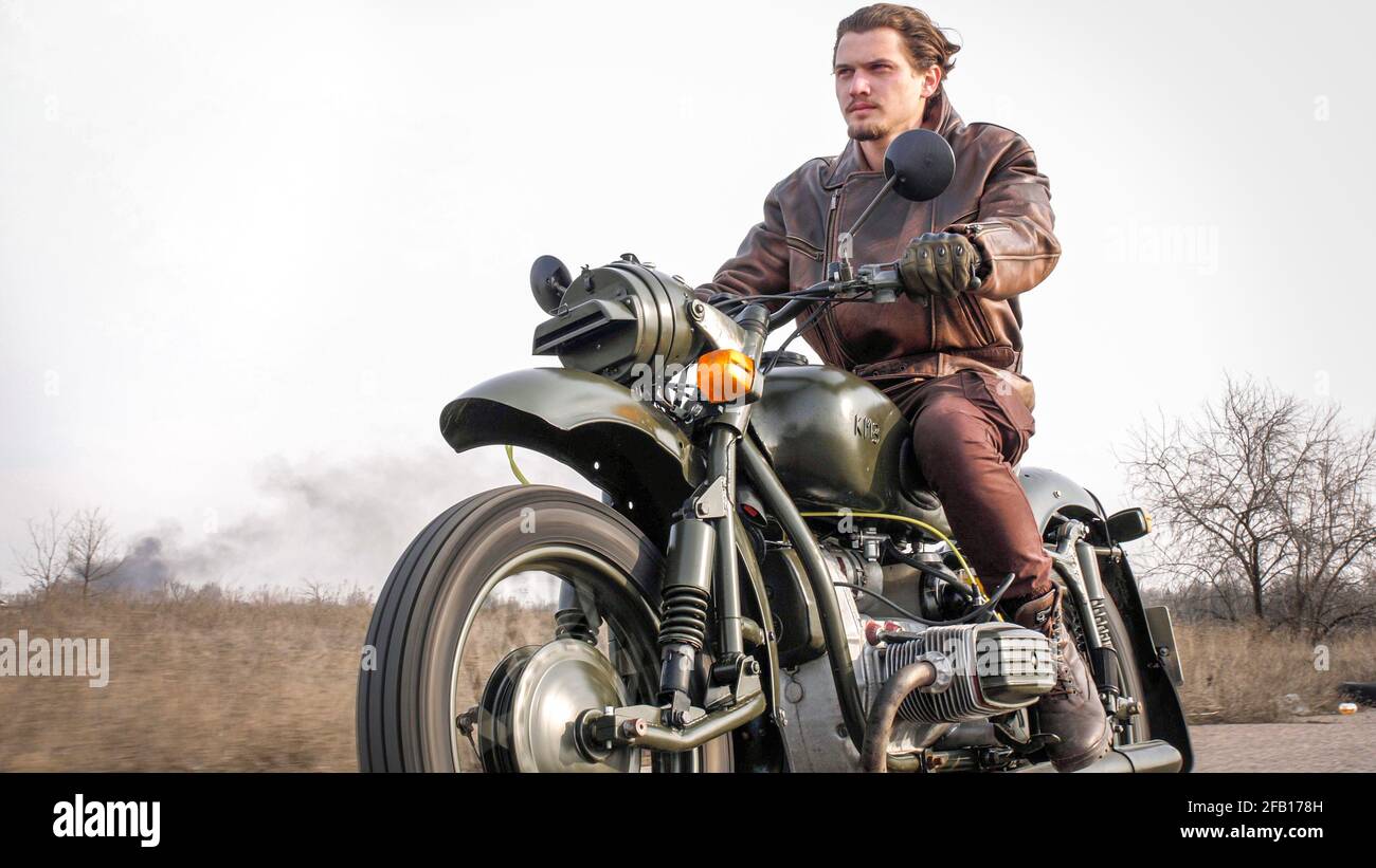 View of stylish cool man in leather jacket riding motorcycle Stock ...