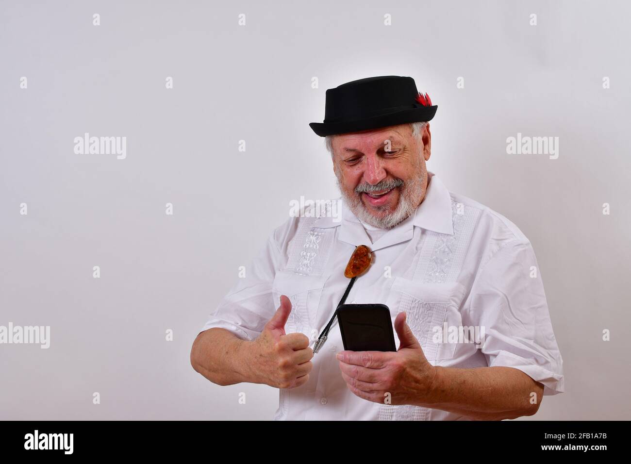 Cheerful old man is using his smartphone Stock Photo - Alamy