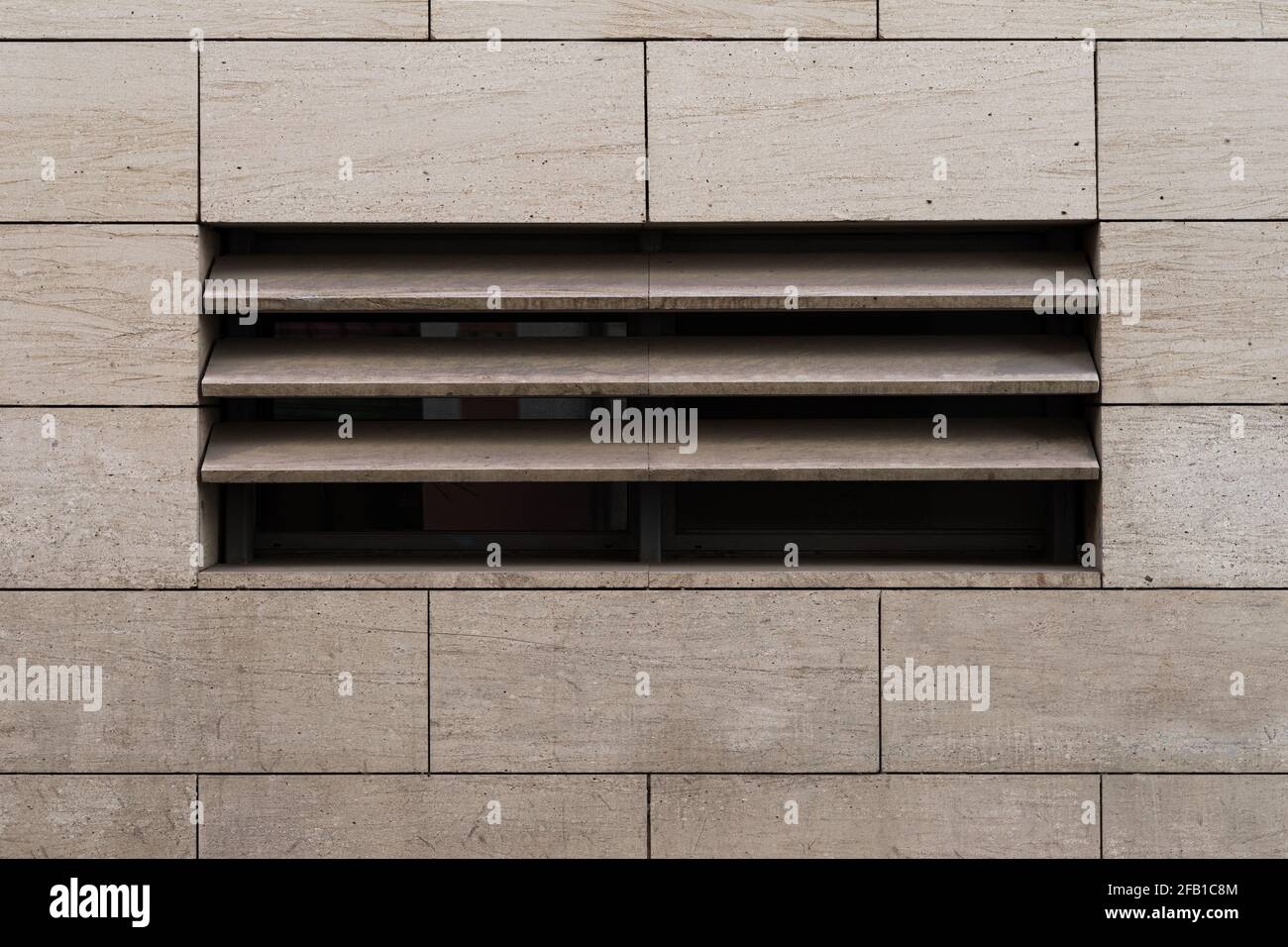 Modern window with stone brise soleil on a stone wall. Valencia, Spain ...