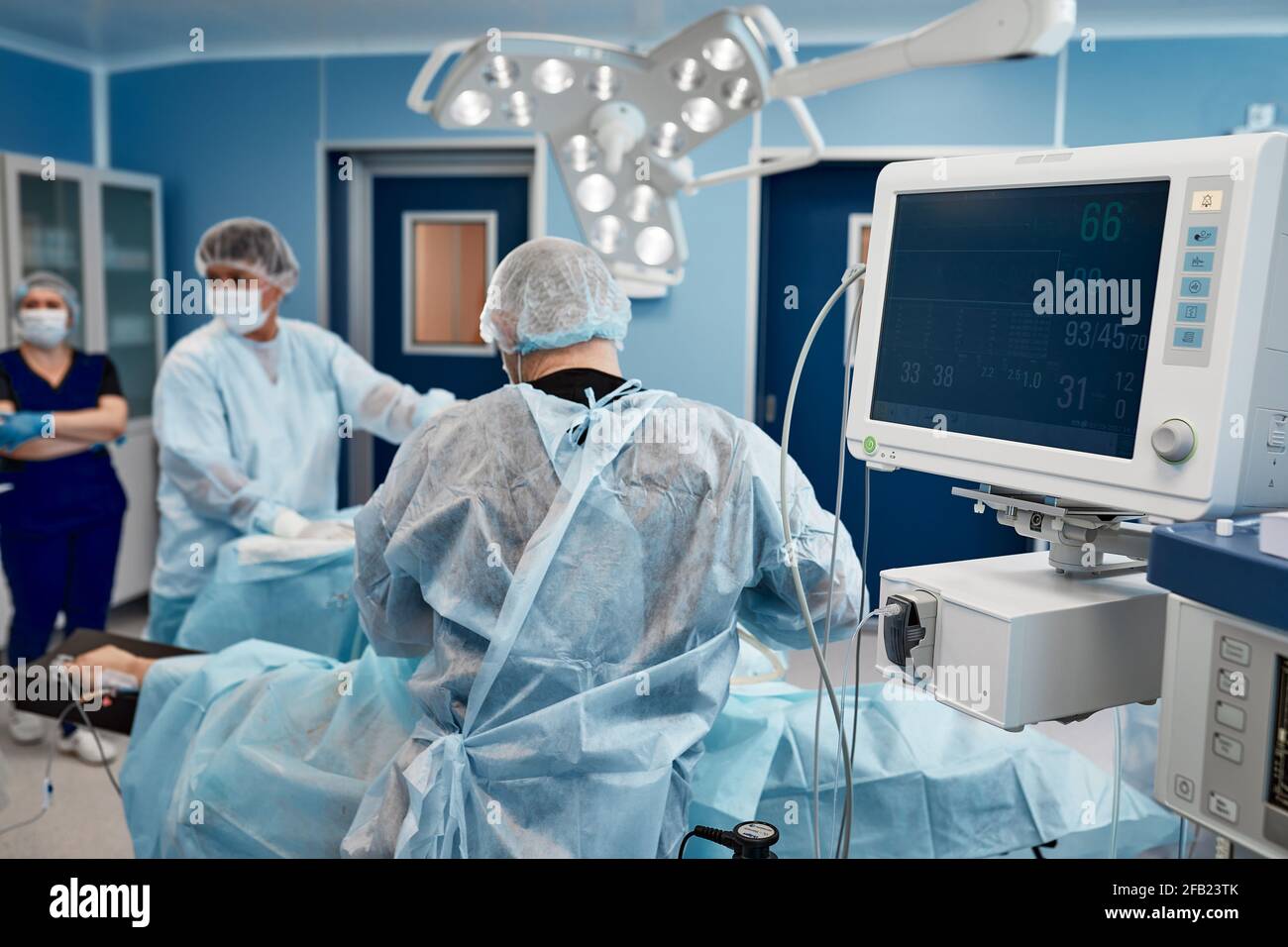 Anesthesiologist keeping track of vital functions of the body during ...