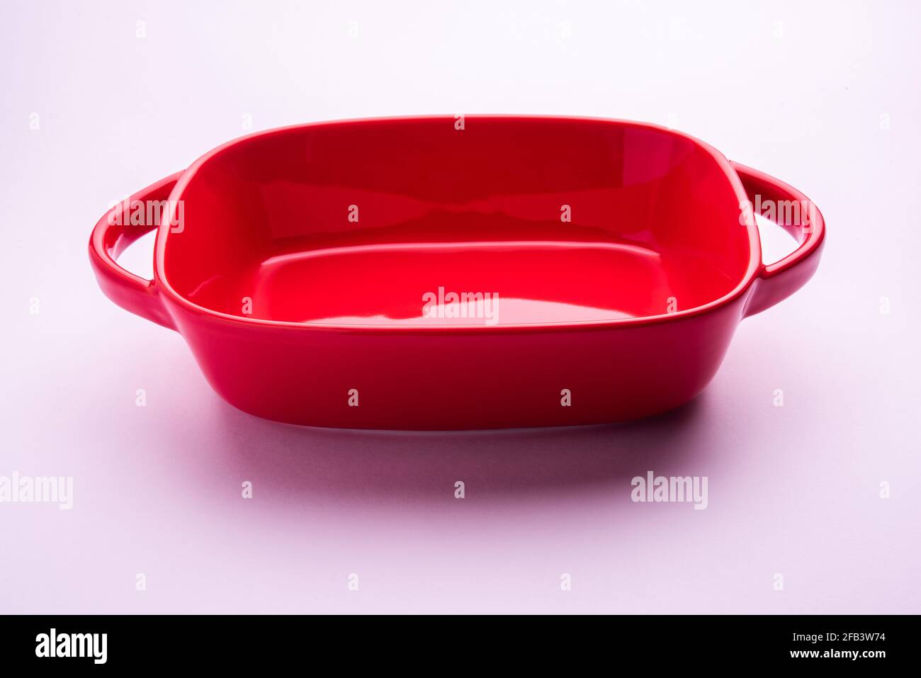 Empty red ceramic serving bowl with handle, isolated over white or gray ...