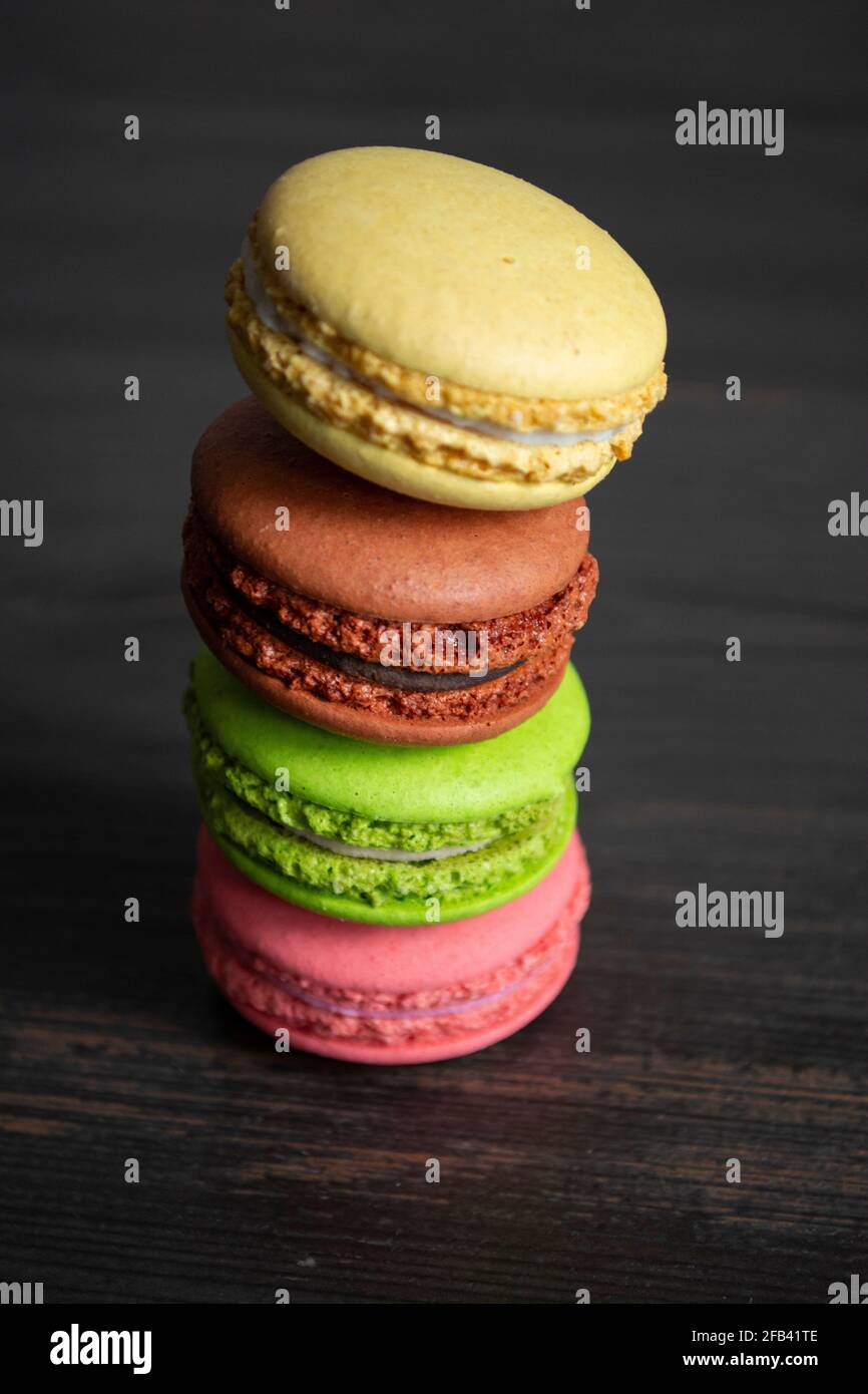 Multi-colored macarons in the black background Stock Photo - Alamy