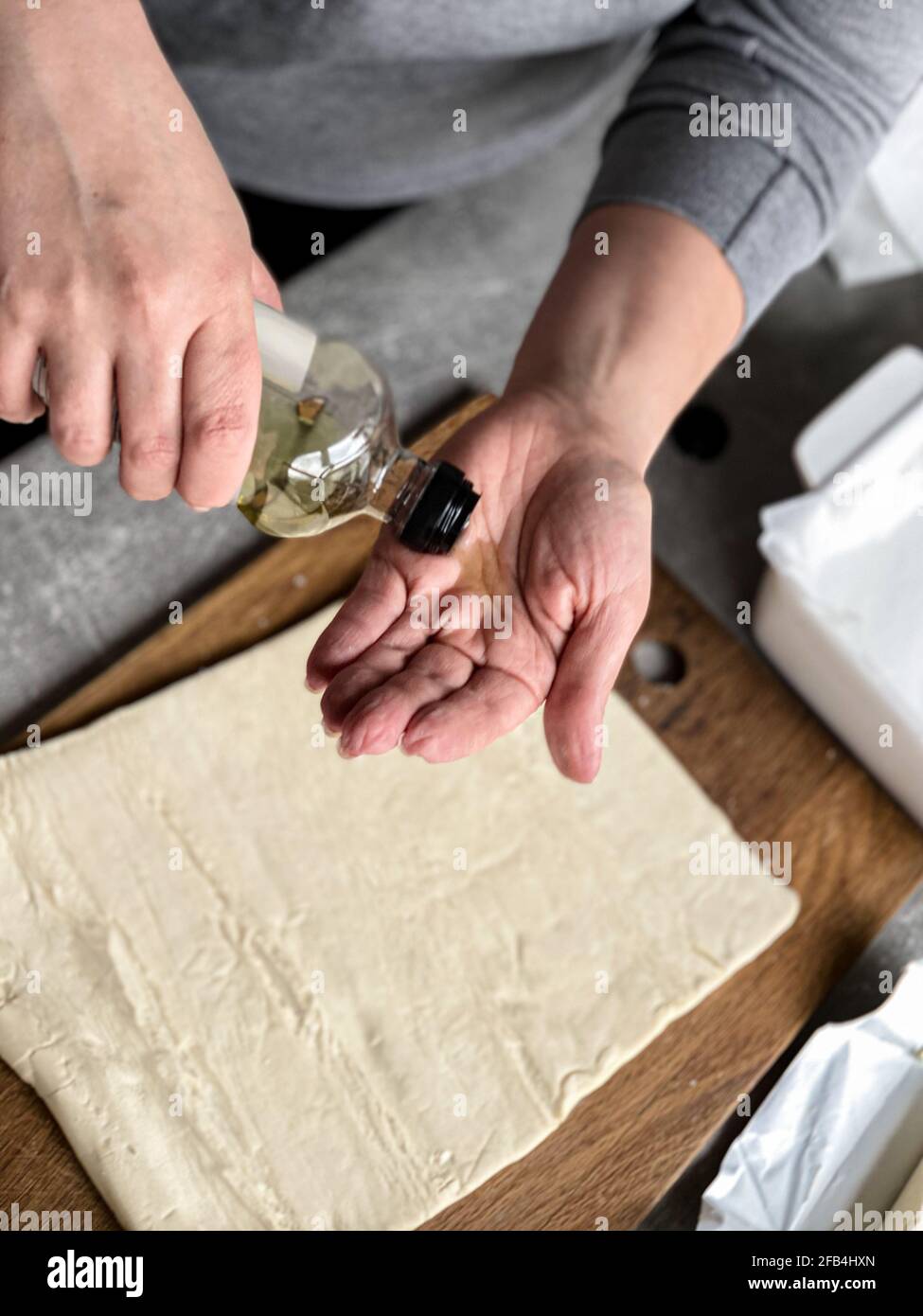 woman pours oil into her hand Stock Photo - Alamy