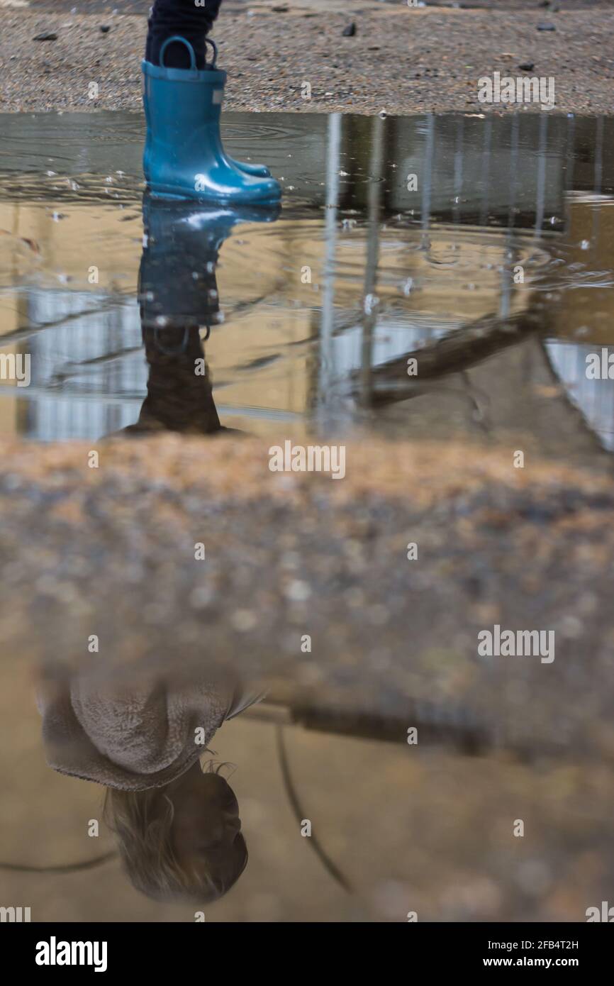 Child splash puddles boots hi-res stock photography and images - Alamy