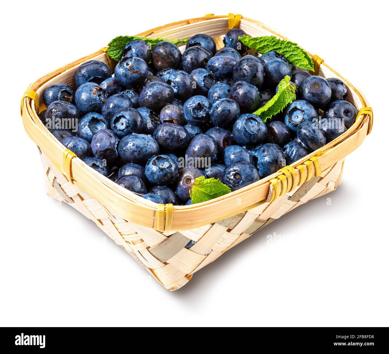 Fresh and raw blueberries with drops of water. In a small wicker basket ...