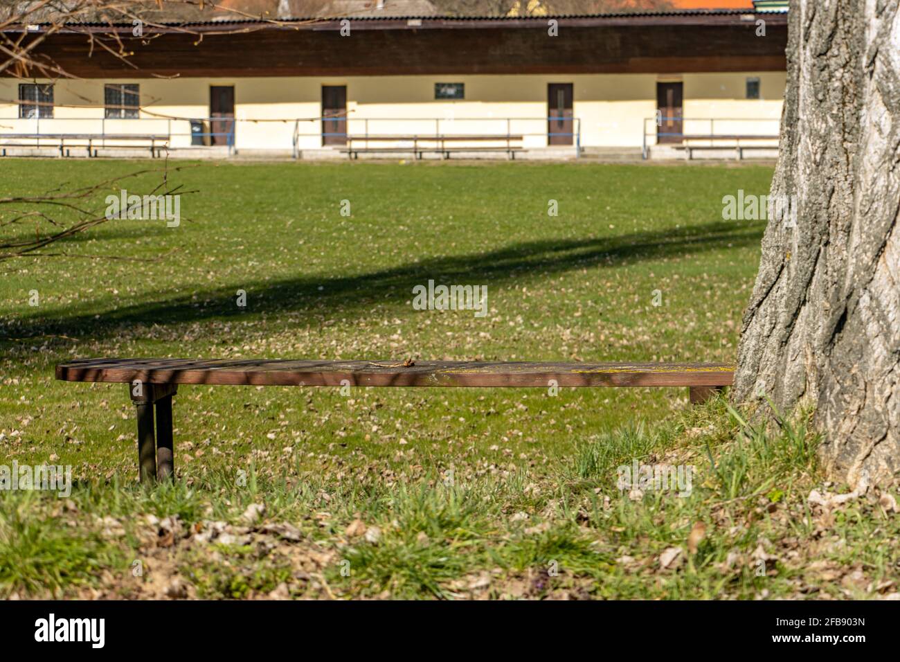 The empty wooden bench at the provincial football playground with ...