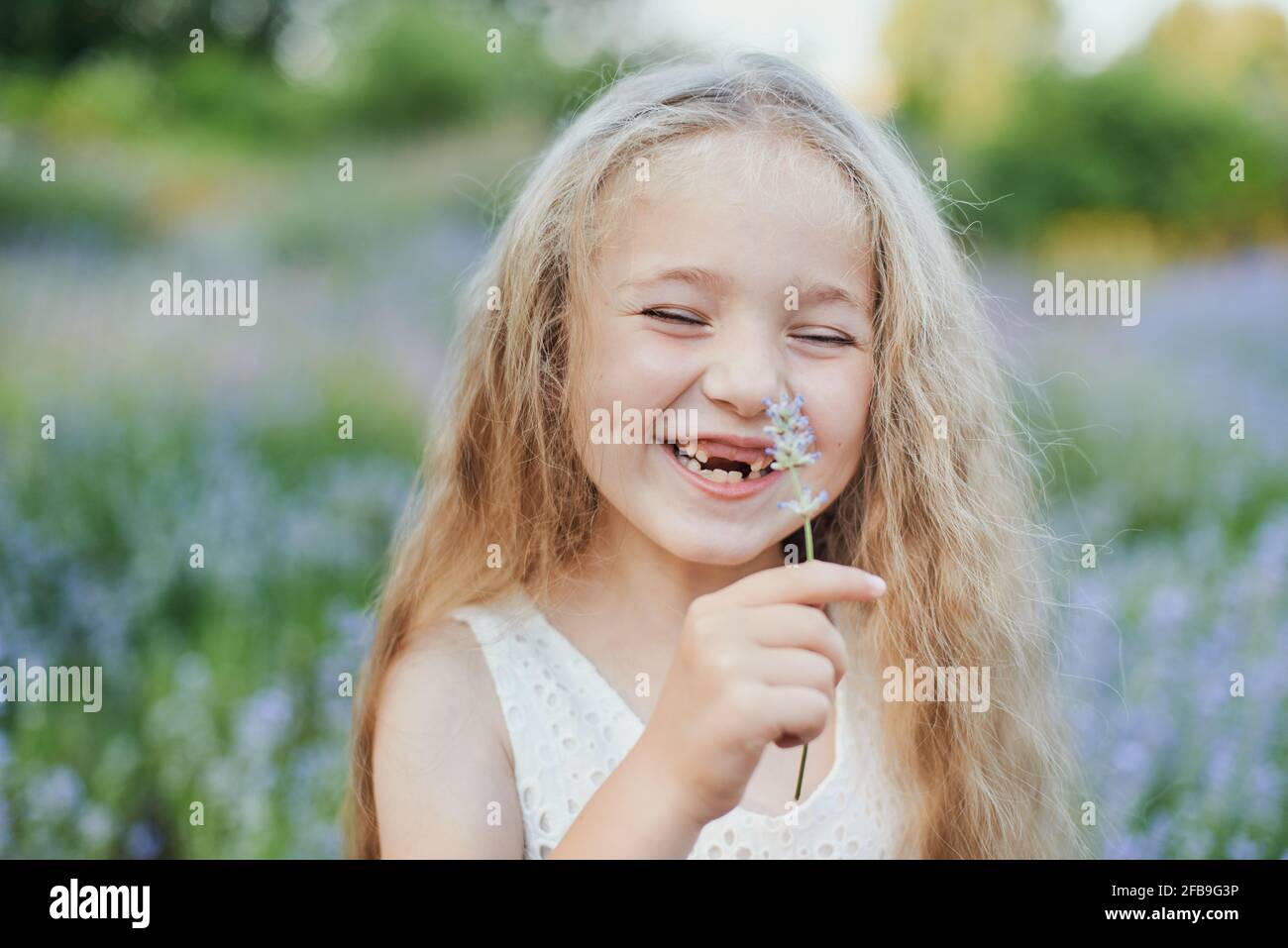 Close up portrait of beautiful joyful blonde Caucasian girl smiling ...