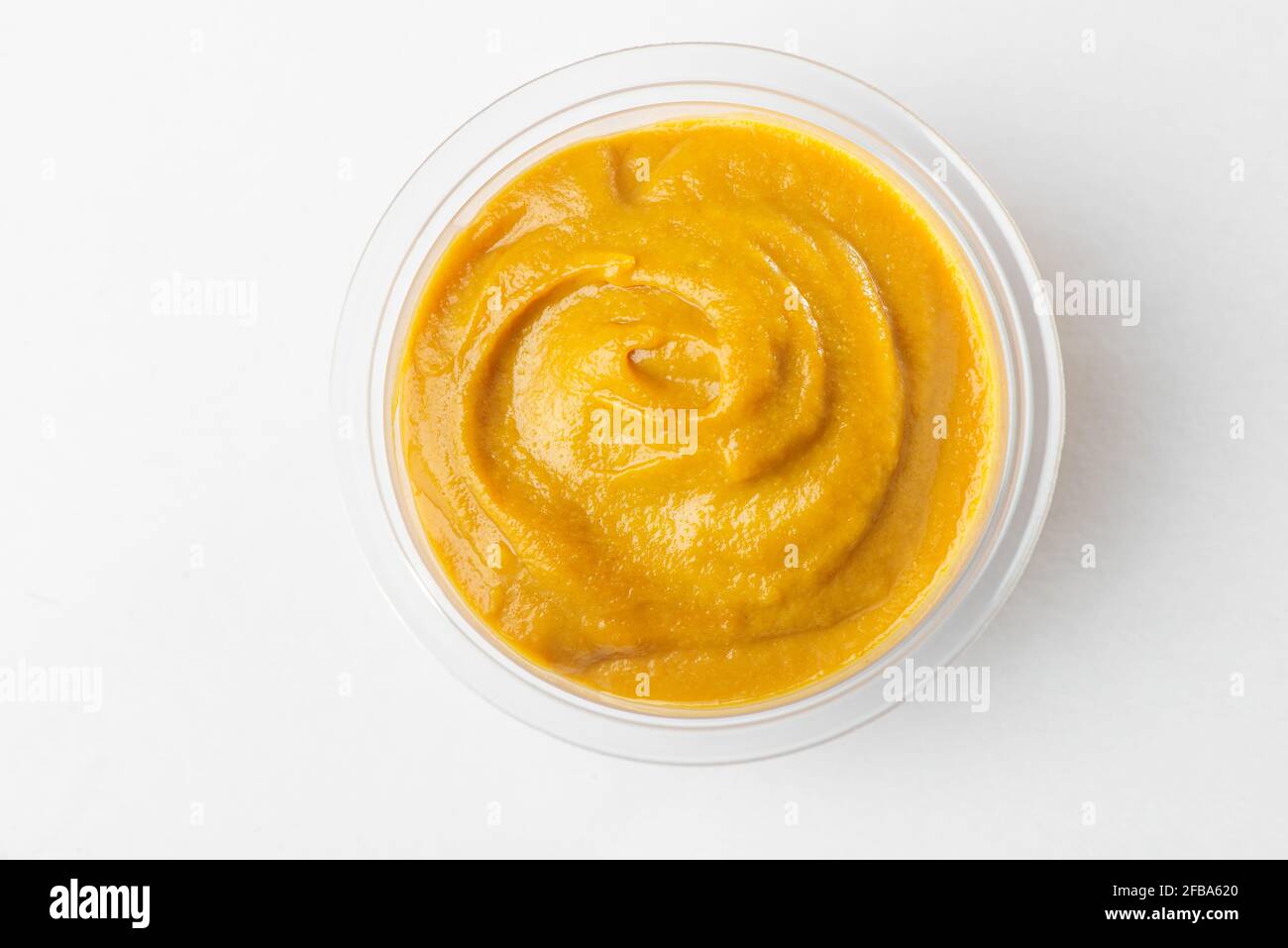 Top view on a cup of liquid mustard on white background Stock Photo - Alamy