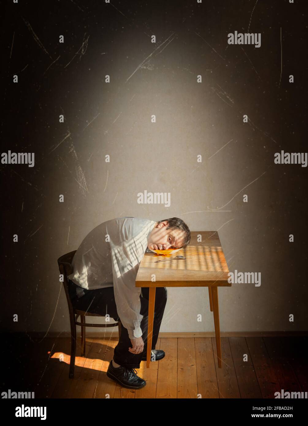 A head of man dropped into a plate with soup on a levitating table ...