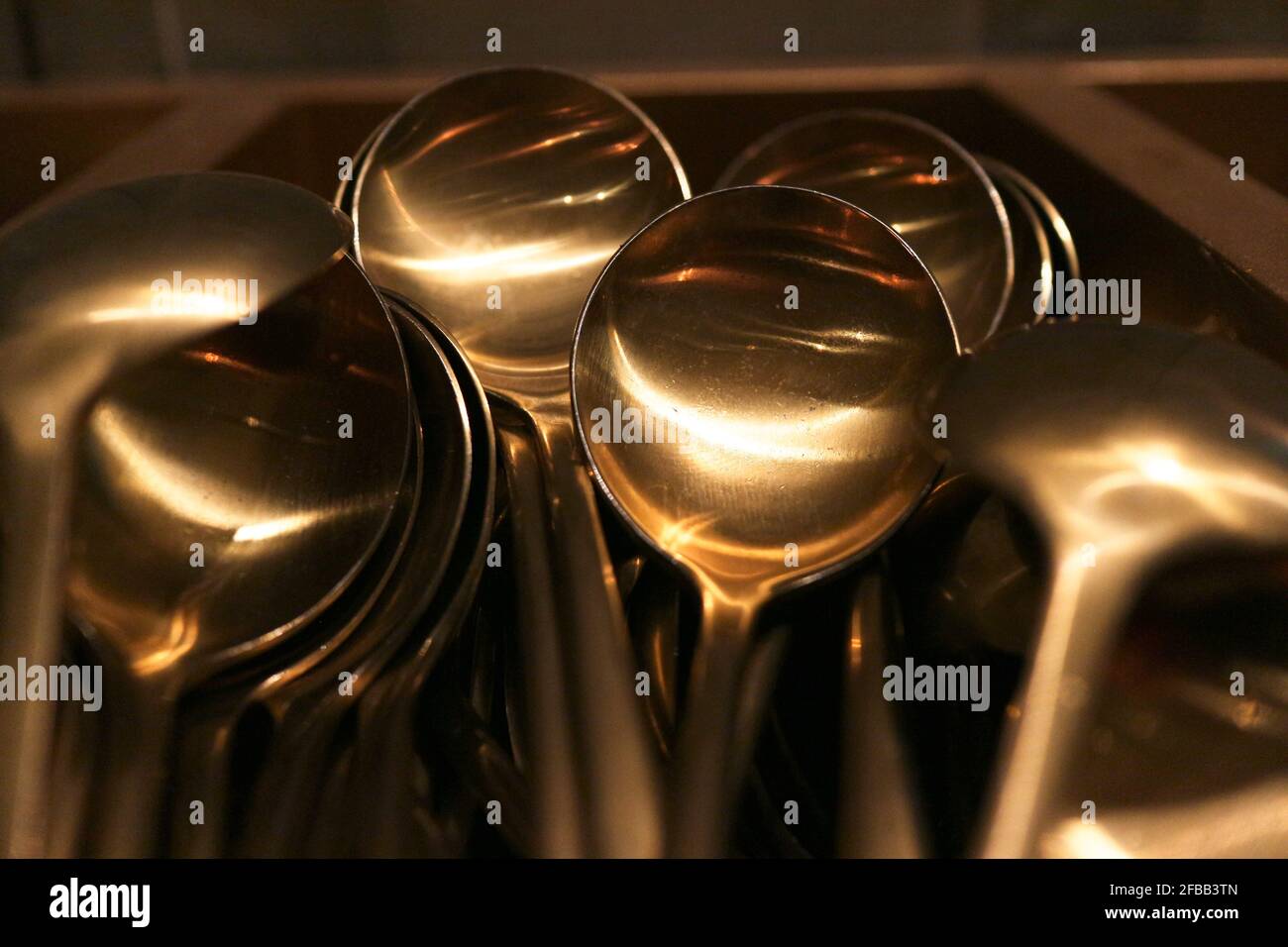 Shiny brass spoons hi-res stock photography and images - Alamy