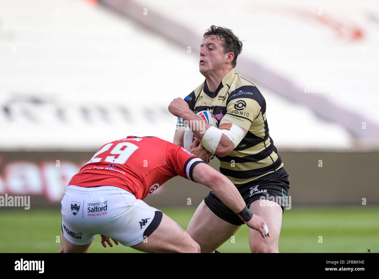 Matty Gee (18) of Leigh Centurions is tackled by Declan Patton (29) of ...