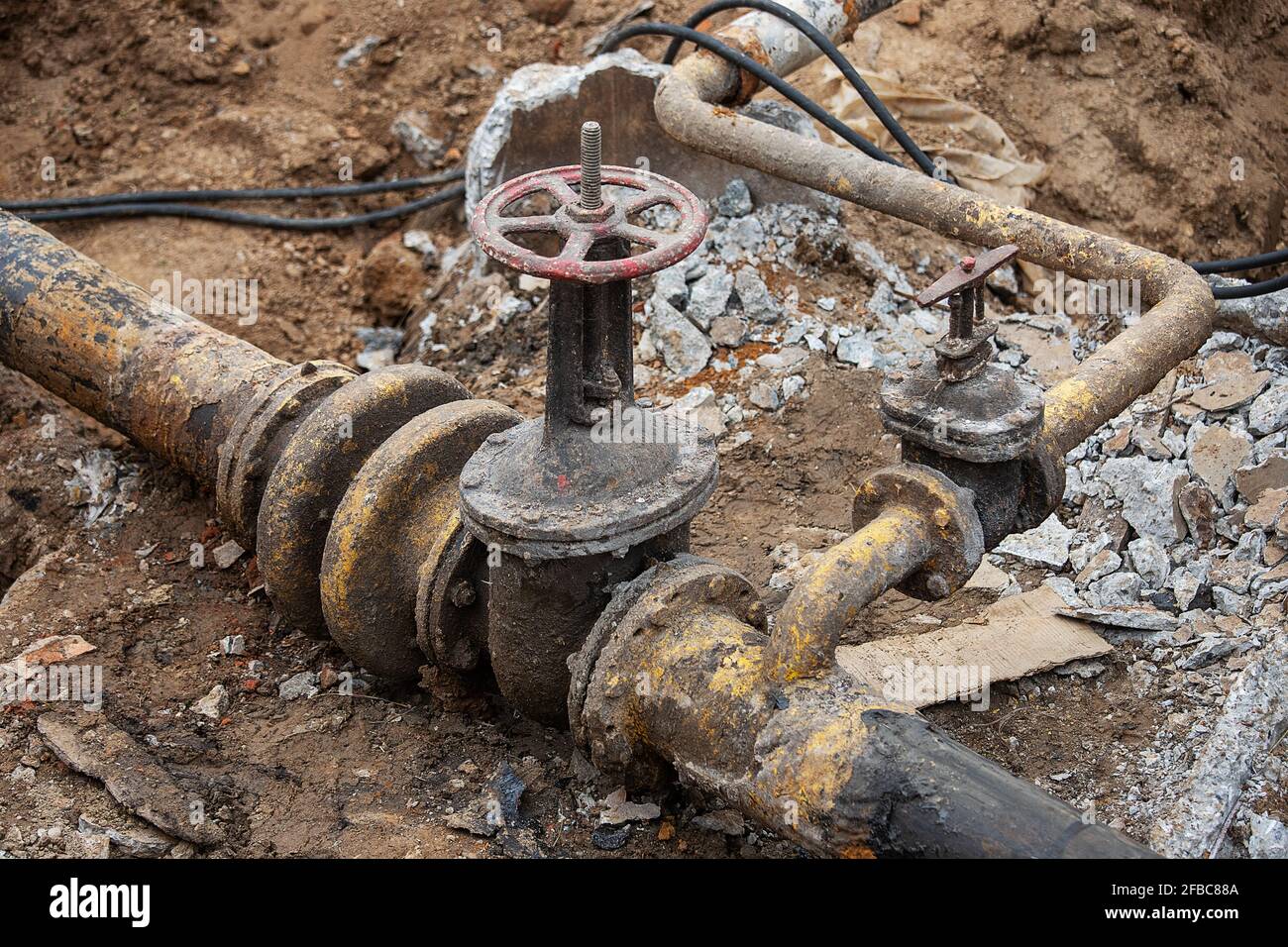 a man working in uniform is engaged in repairing the gas pipe ...
