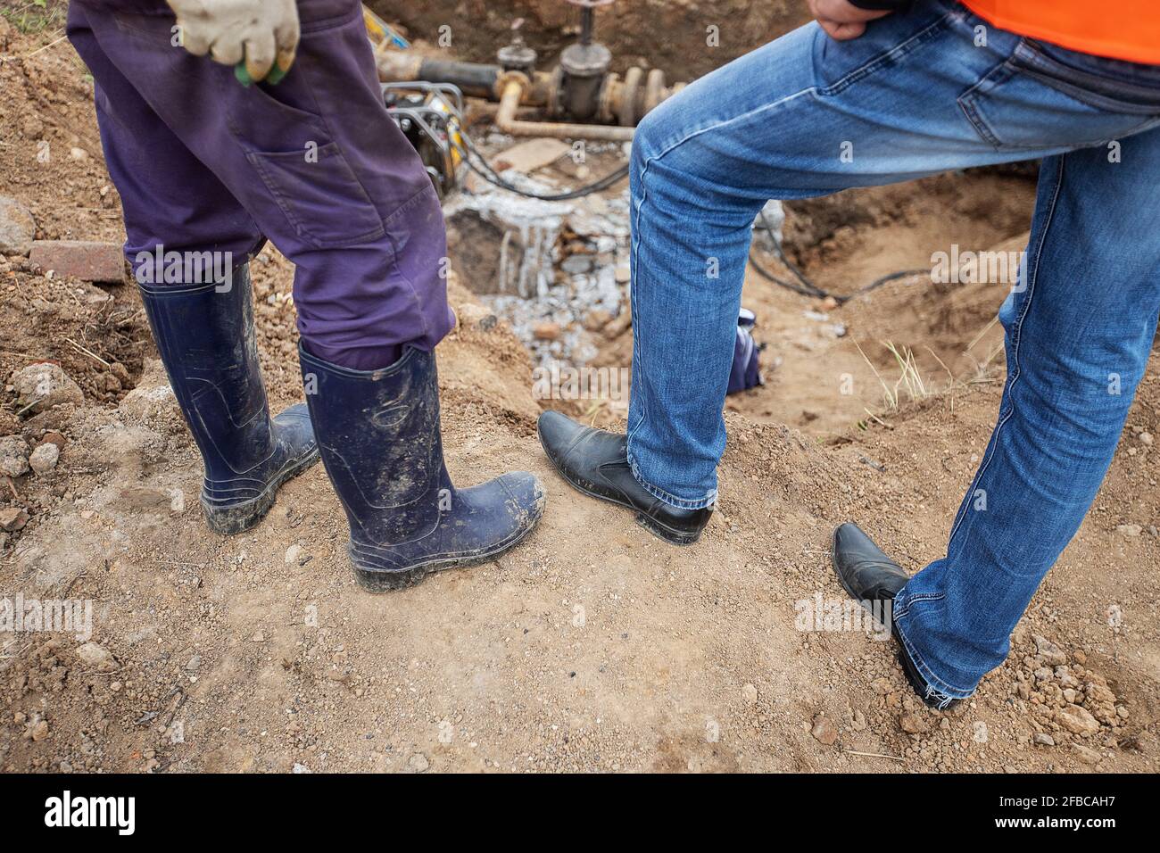 a man working in uniform is engaged in repairing the gas pipe ...