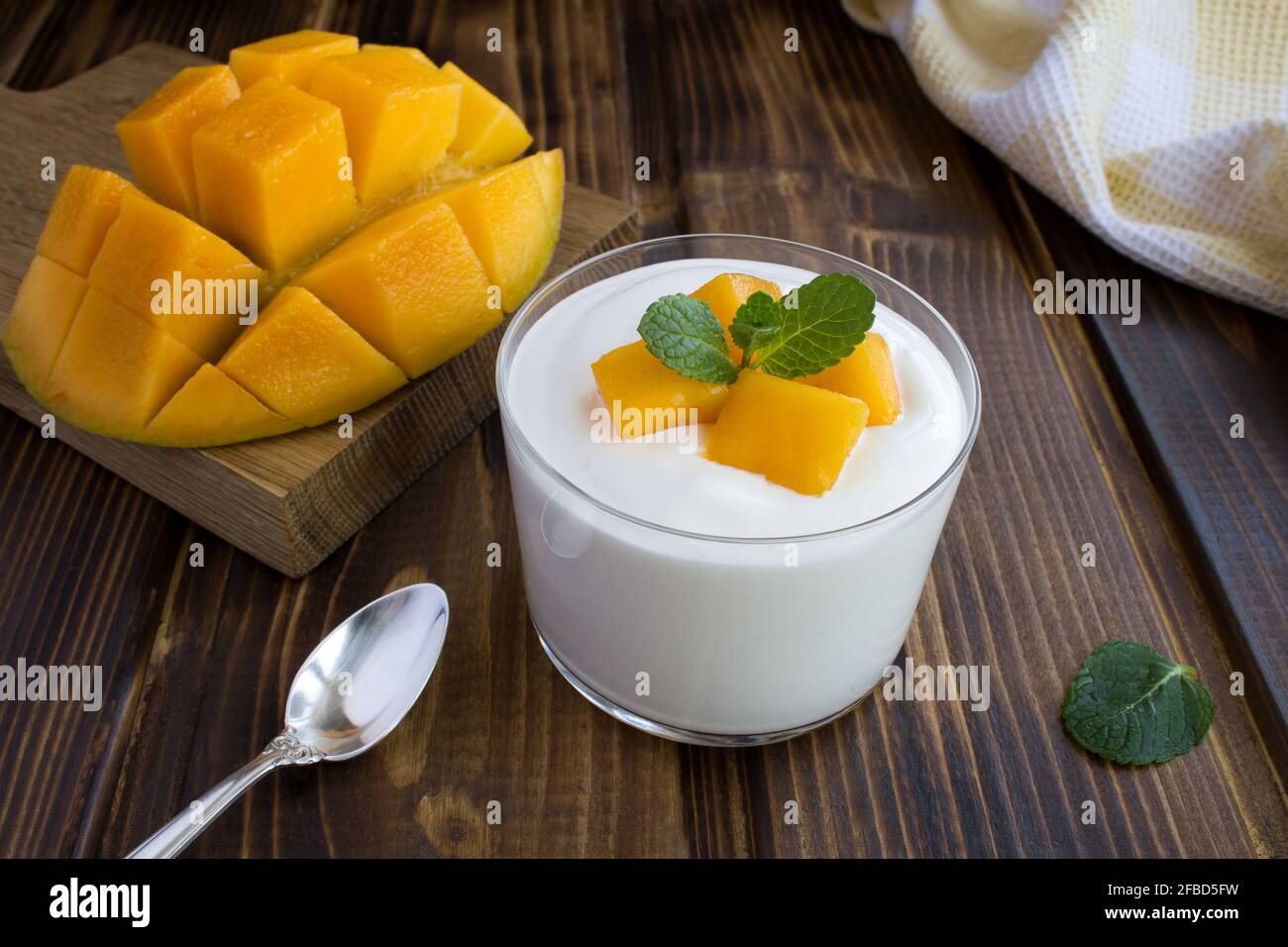 Milk yogurt with mango on the brown wooden background Stock Photo - Alamy