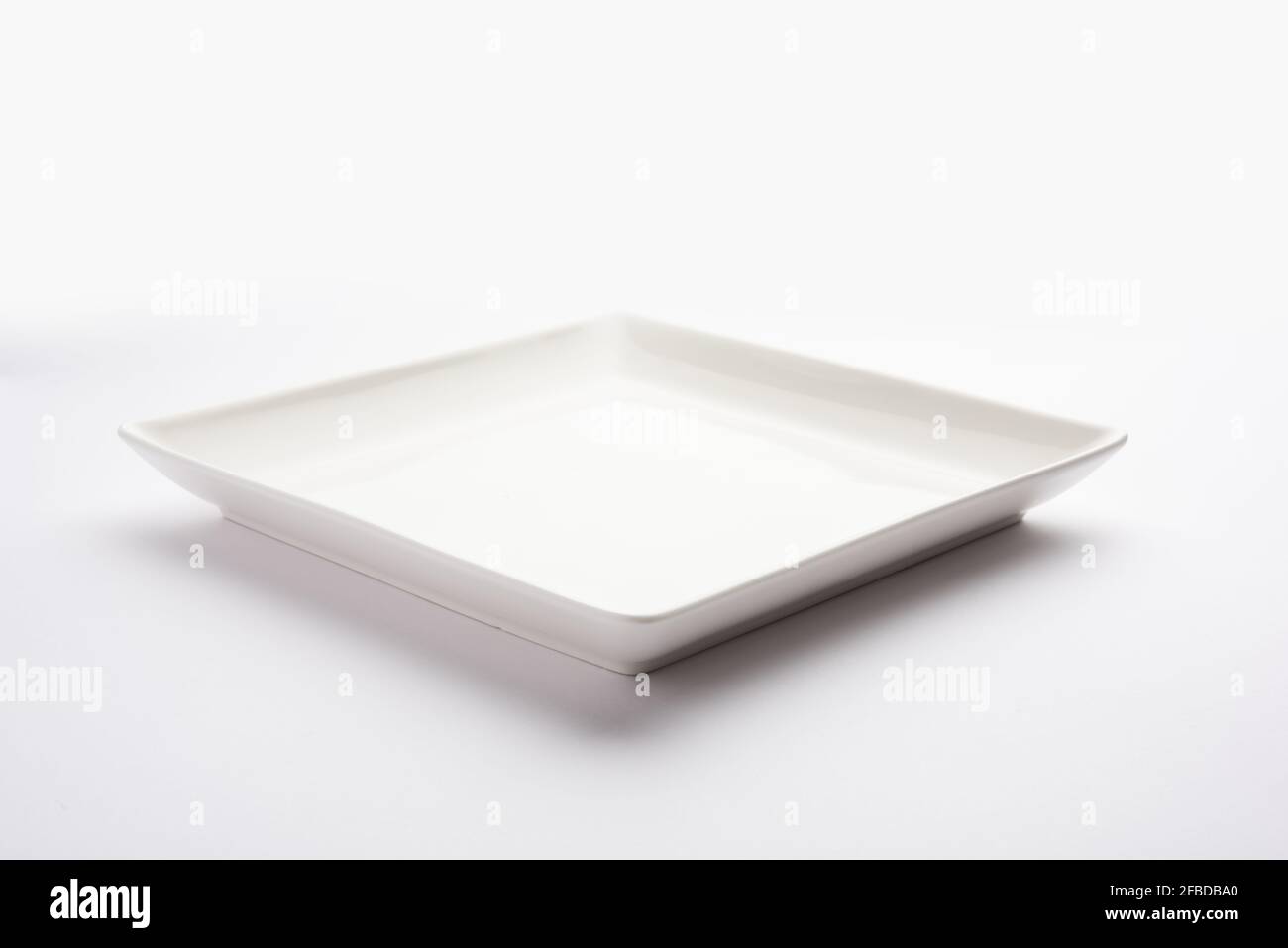 Empty white ceramic square plate isolated on white background Stock ...