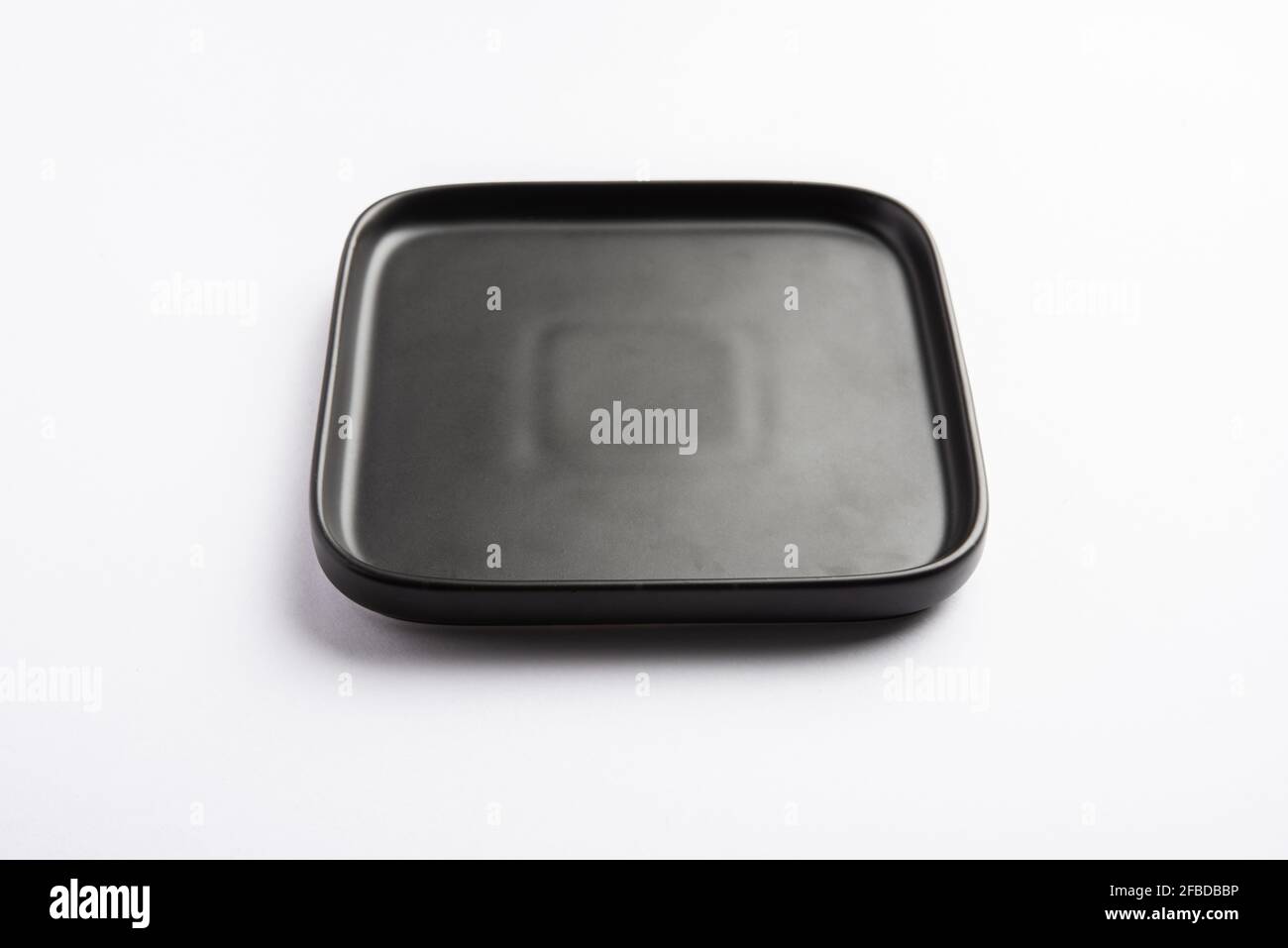 Empty black ceramic square plate isolated on white background Stock ...