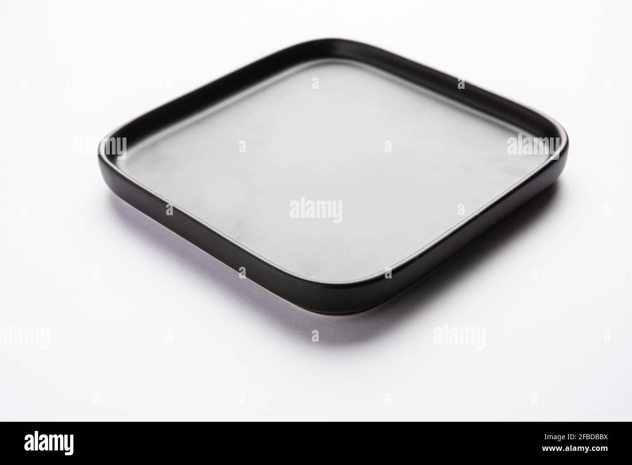 Empty black ceramic square plate isolated on white background Stock ...
