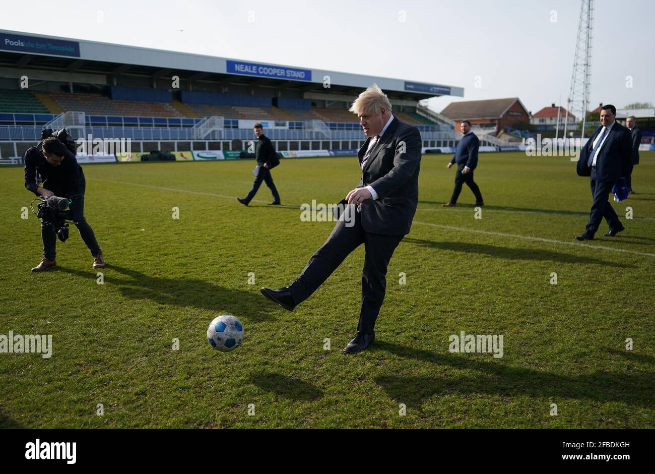 Prime Minister Boris Johnson kicking a football during a visit to the ...