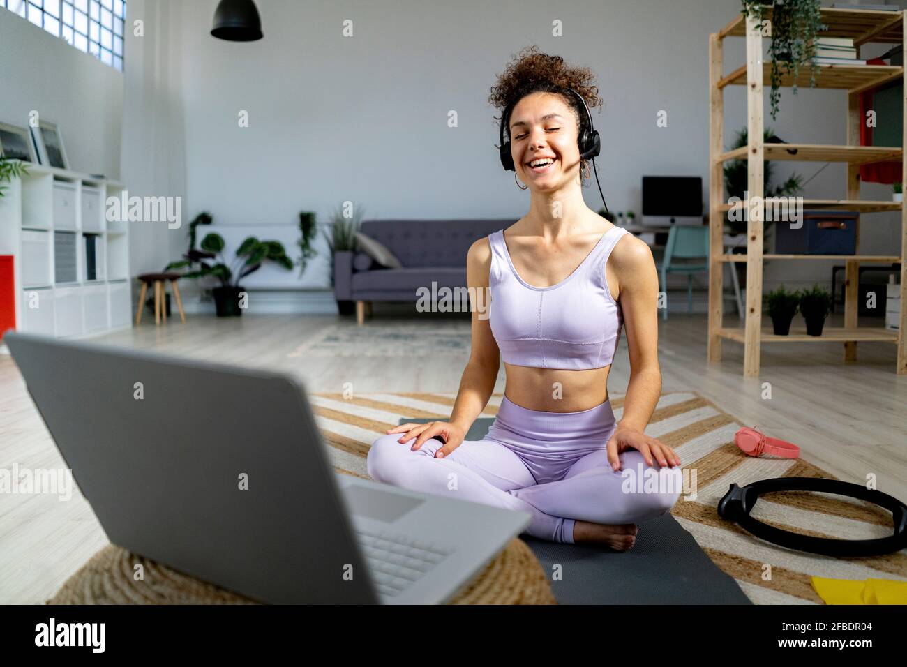 Smiling female influencer talking during vlogging through laptop in ...