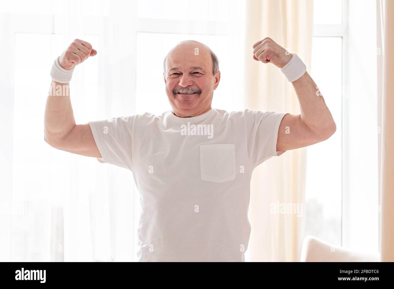 Senior man showing muscle being proud with his health and body Stock ...