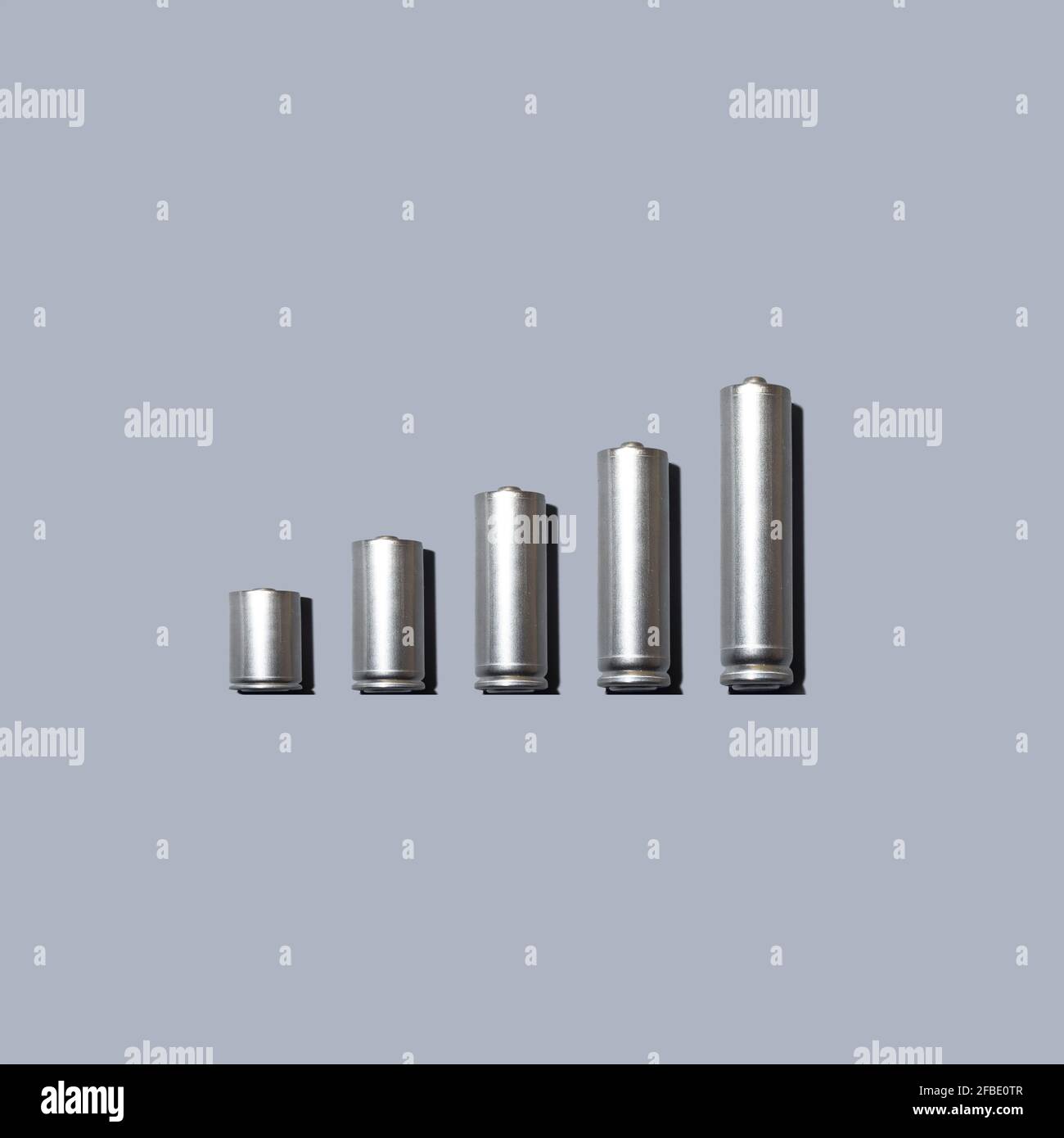 Growing bar graph made from battery on grey background. Success ...