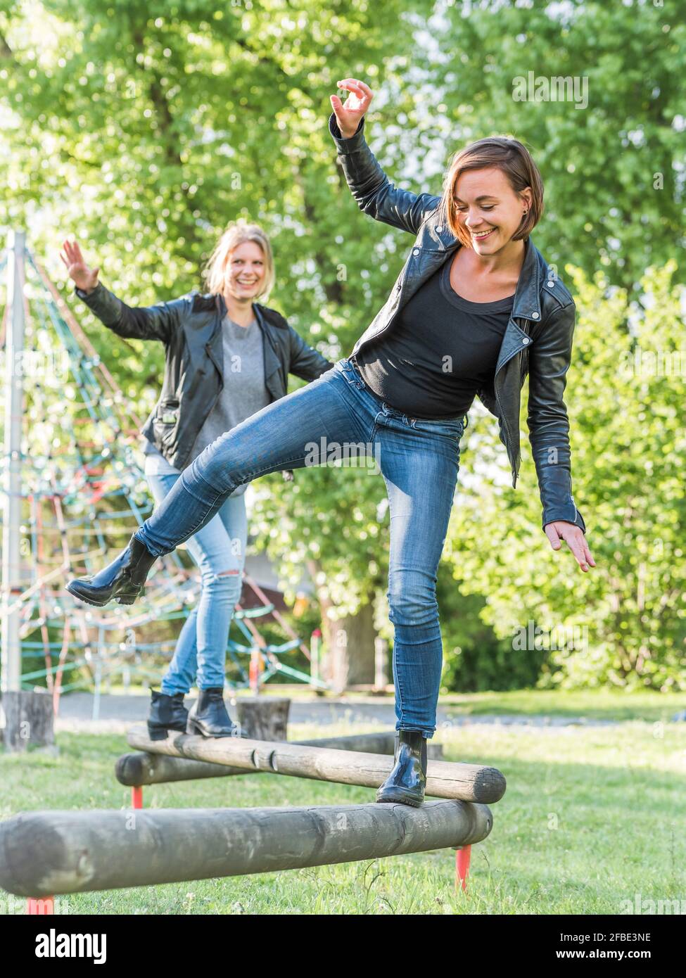 Two friends having fun on playground Stock Photo - Alamy