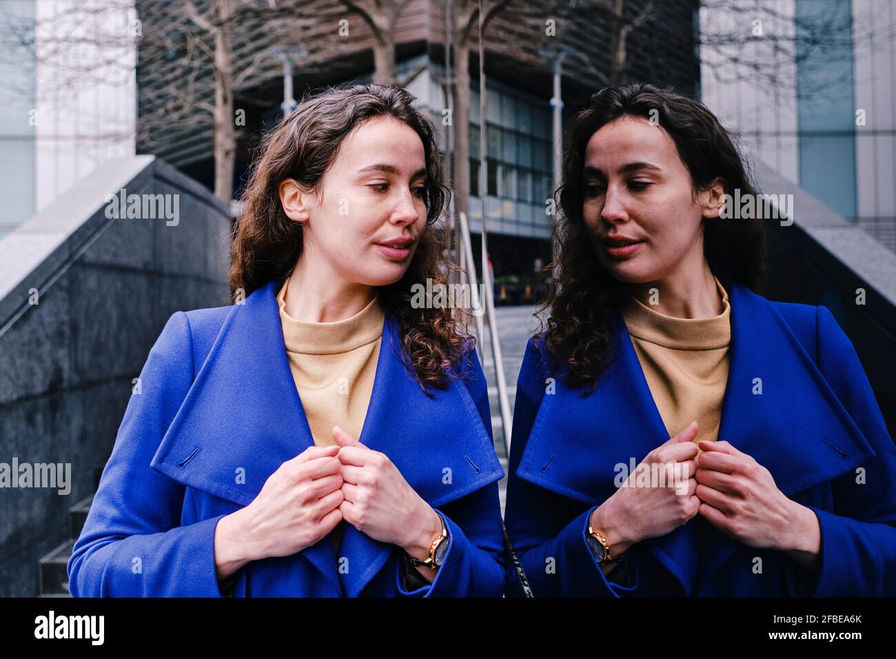 Beautiful female professional looking at reflection Stock Photo - Alamy