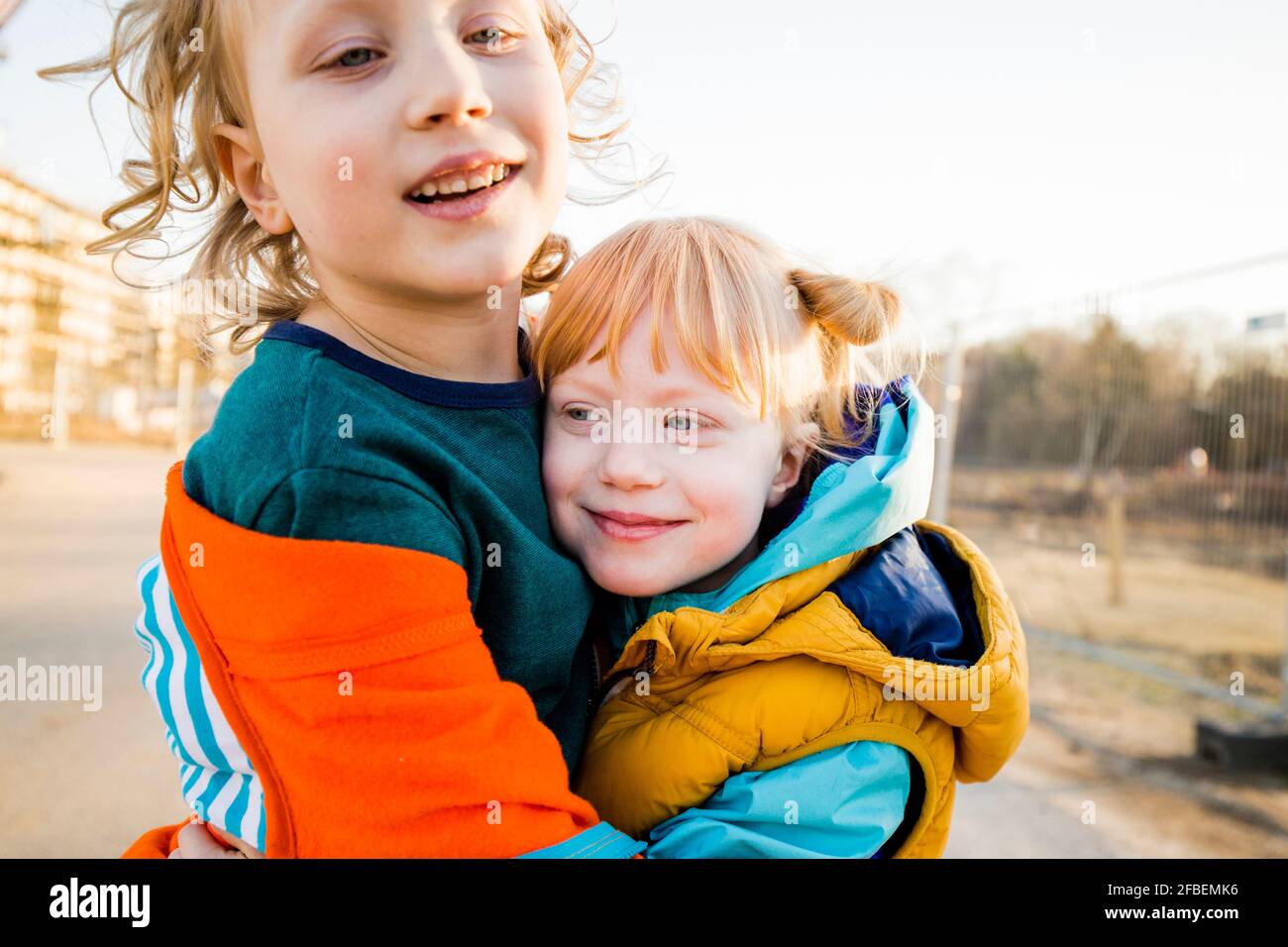 Smiling boy hugging cute sister Stock Photo - Alamy
